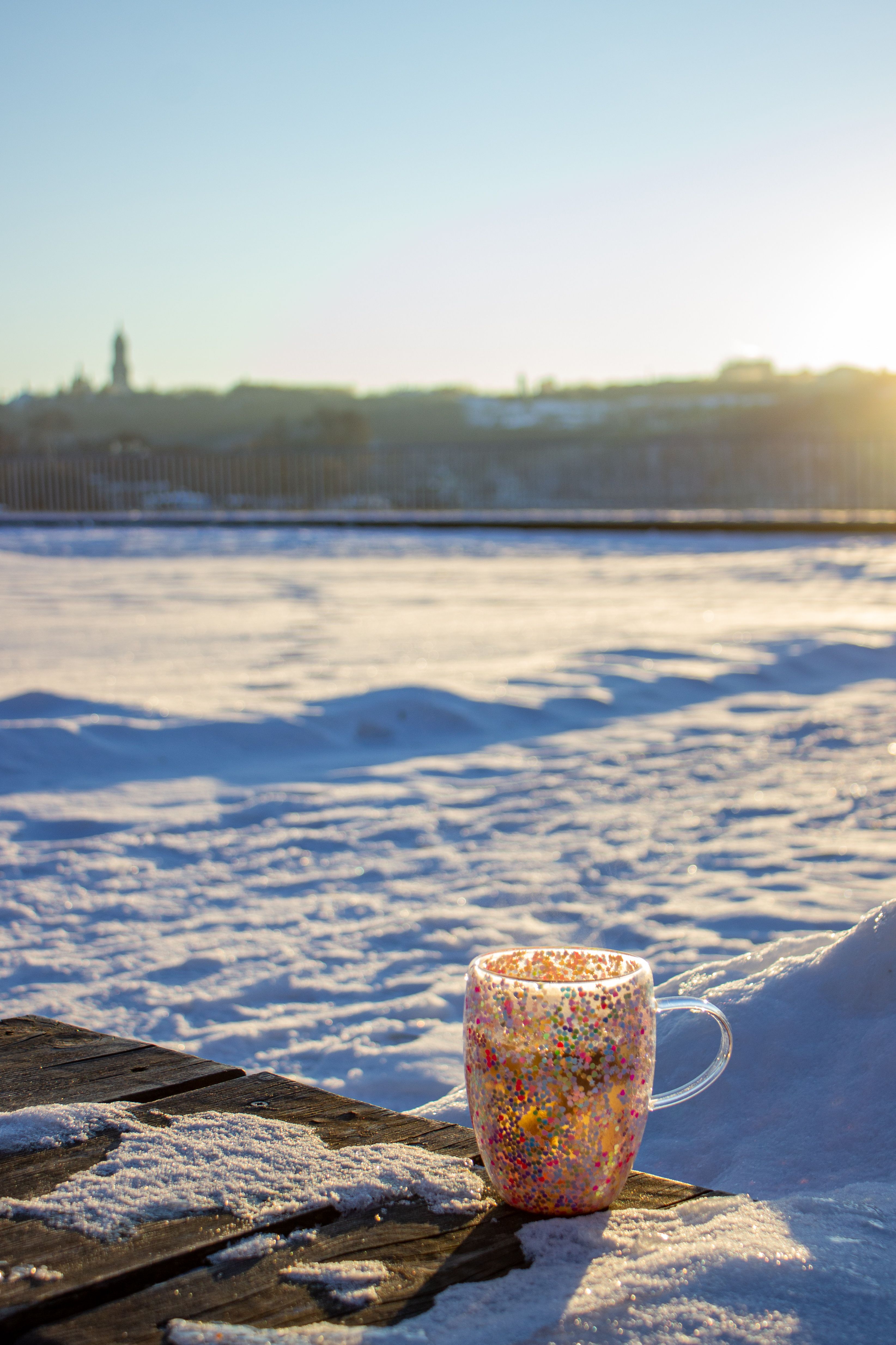 Red Thermos and Mug on Snowy Wooden Bench · Free Stock Photo