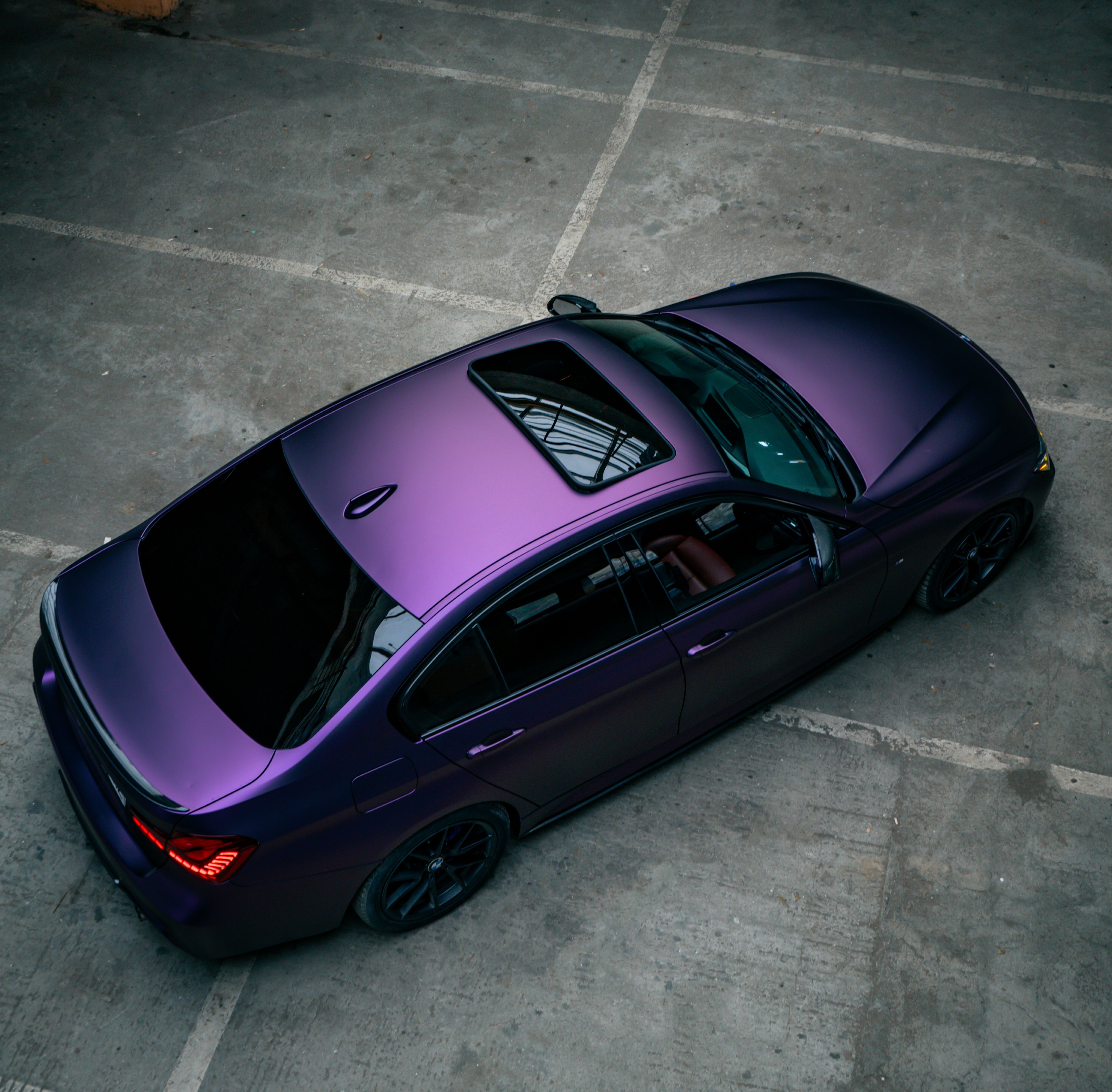 Aerial View of Stylish Purple Sedan in Parking Lot · Free Stock Photo