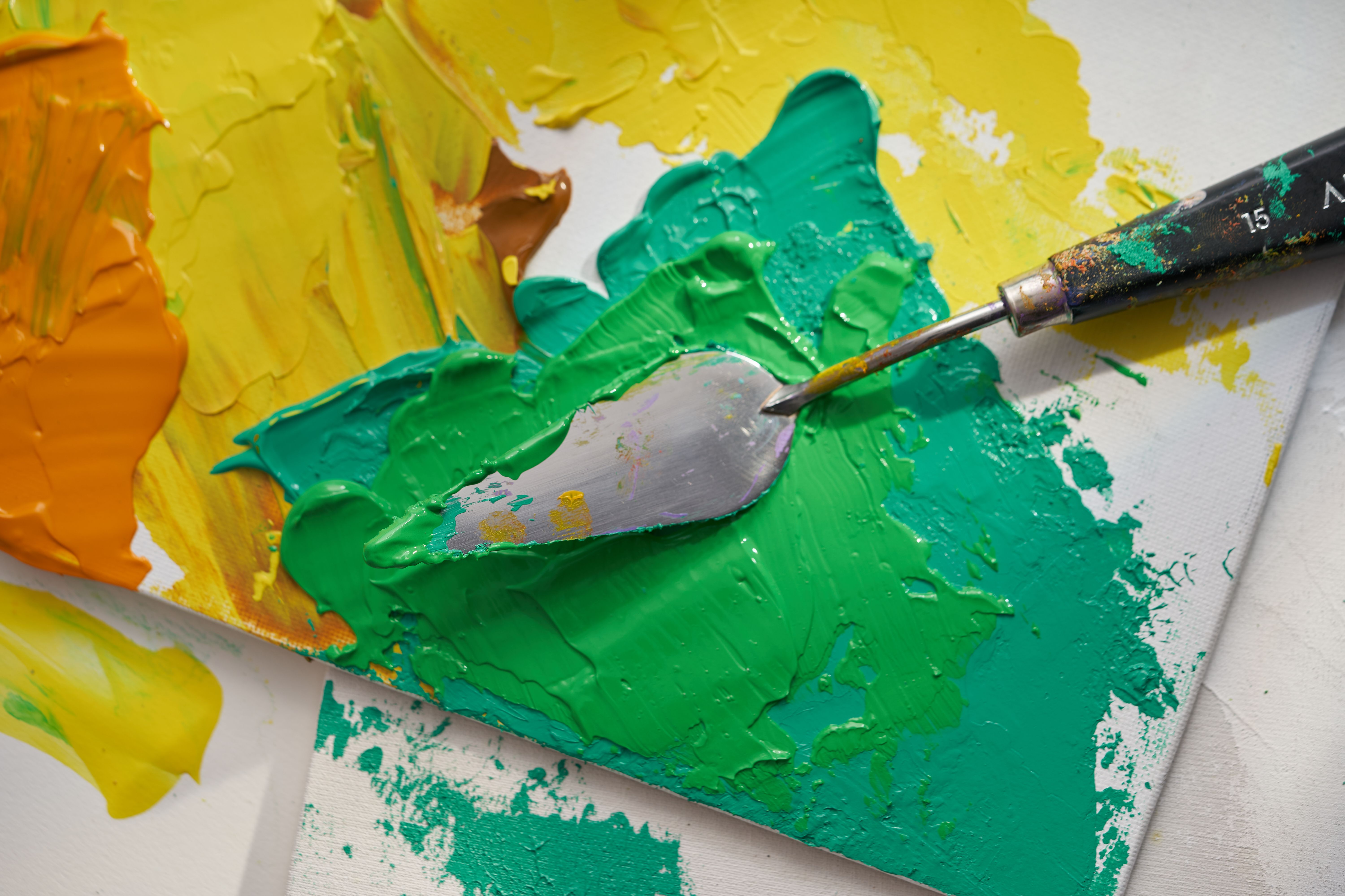 Close-up Photo of a Palette with Messy Painting Colors · Free Stock Photo