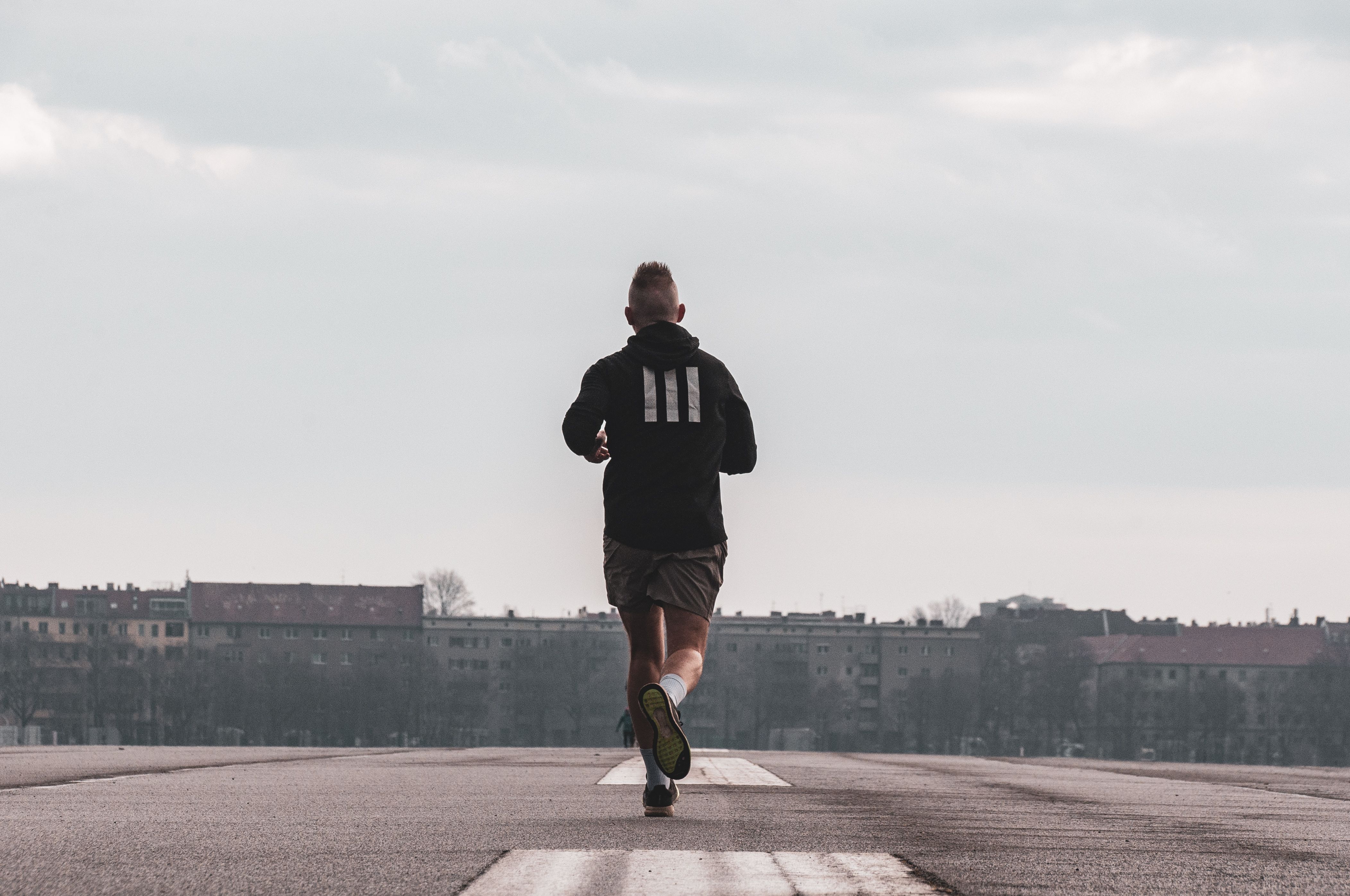 Man Running on Urban Runway at Dawn · Free Stock Photo