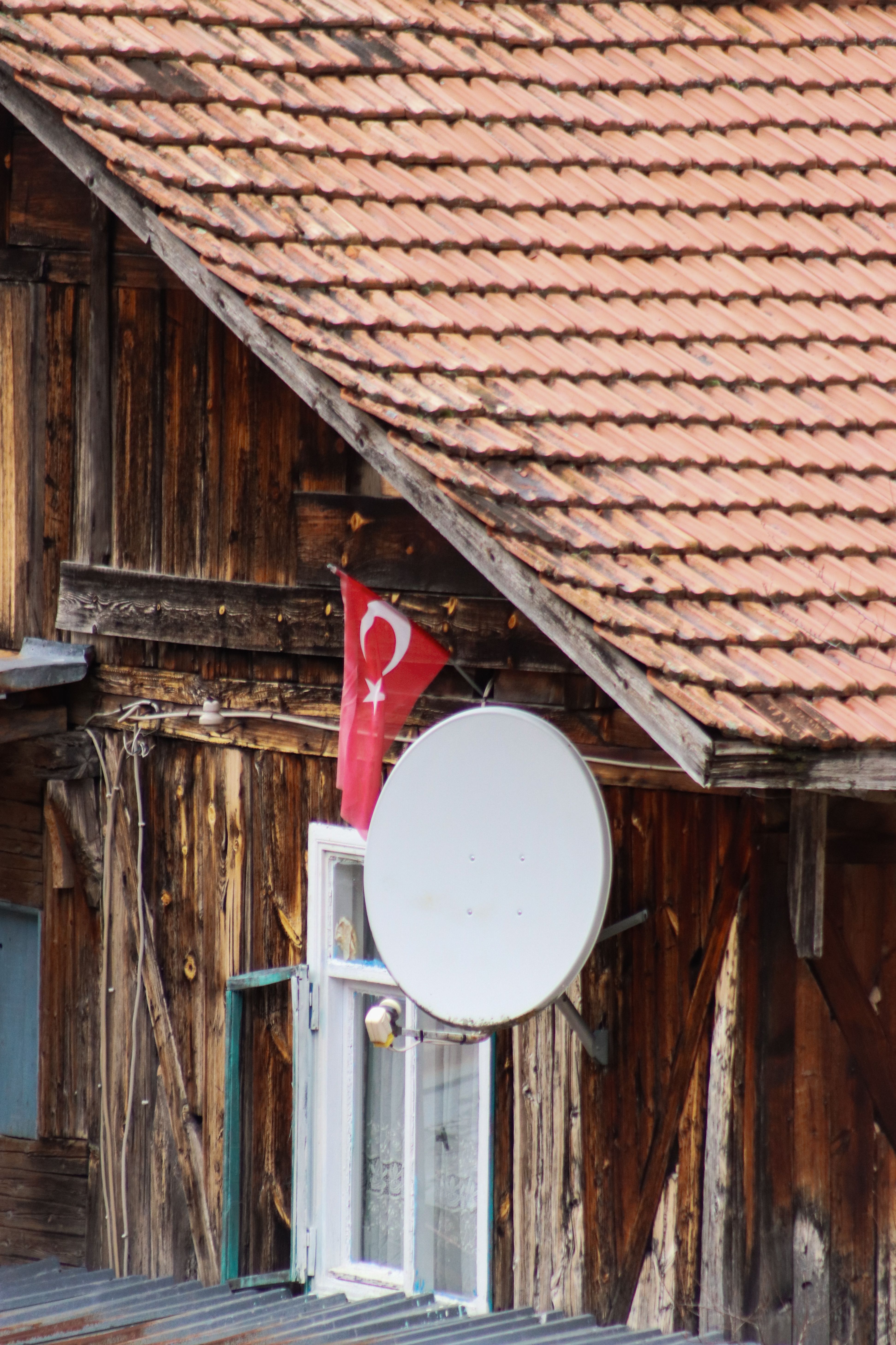 Traditional Turkish House with Flag and Satellite Dish · Free Stock Photo