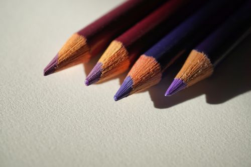 Purple Coloring Pencils on White Table · Free Stock Photo