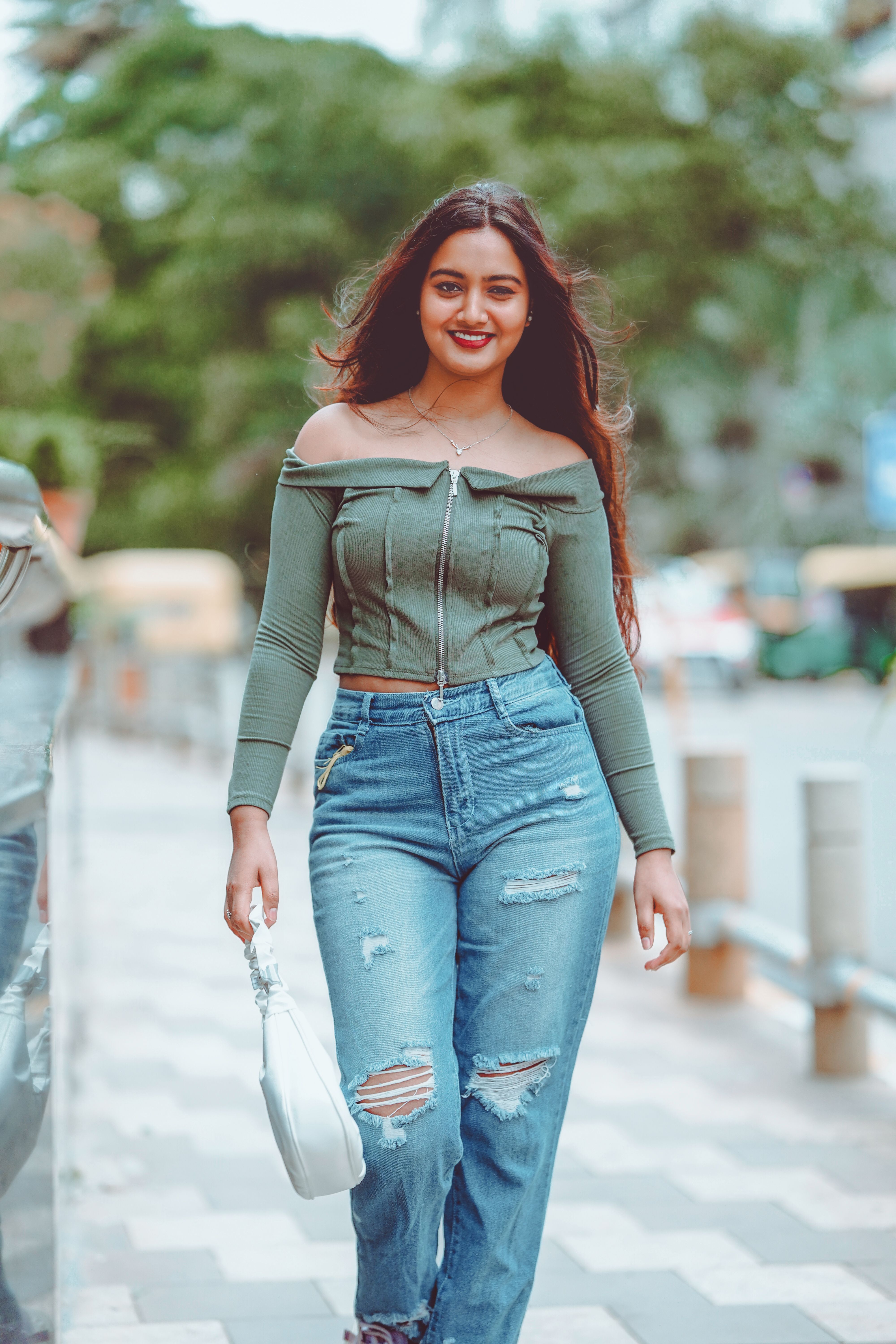 Young woman walking confidently on urban street · Free Stock Photo