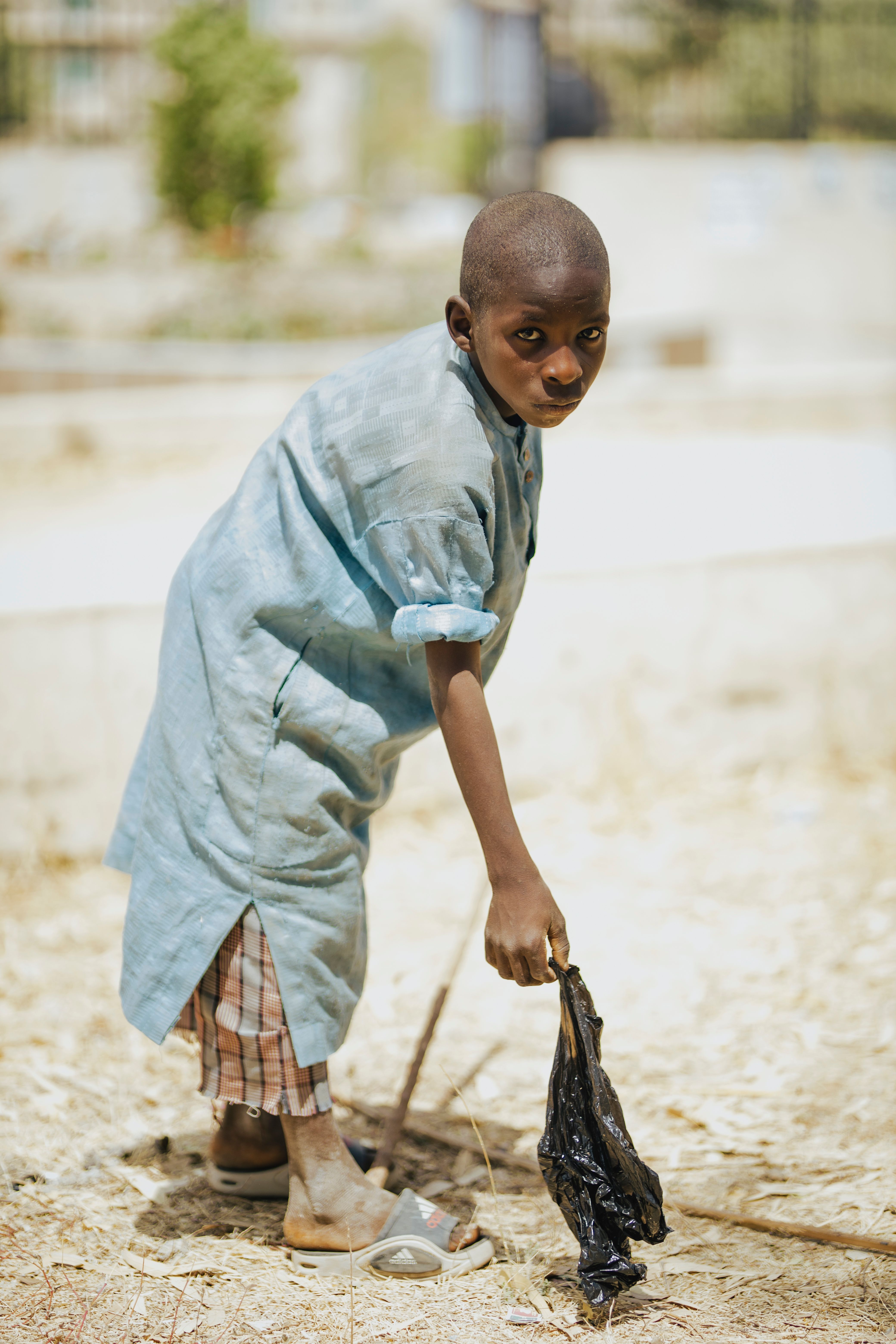 Young Boy Gathering Materials Outdoors · Free Stock Photo