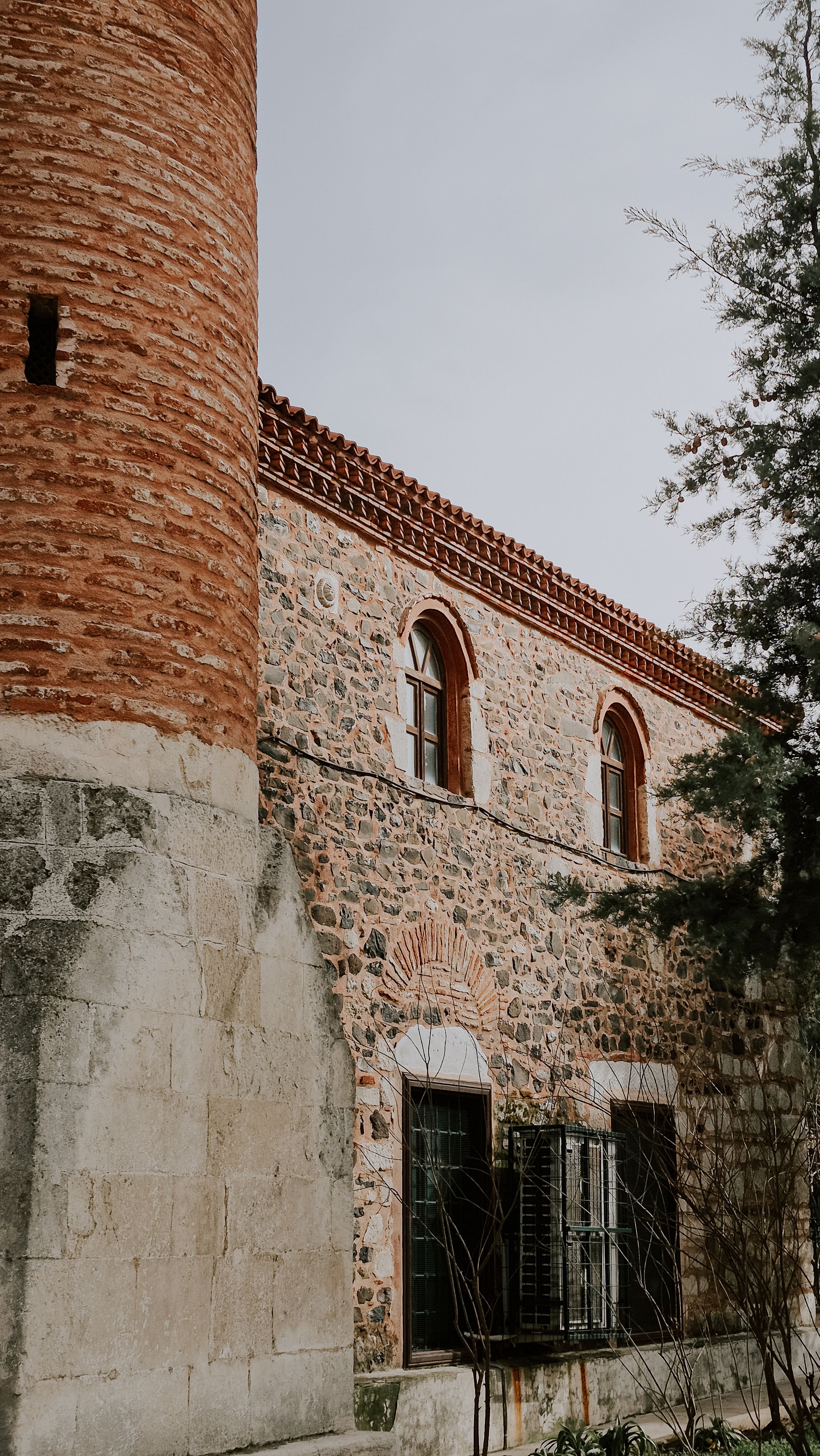 Historic Stone Building with Brick Tower · Free Stock Photo