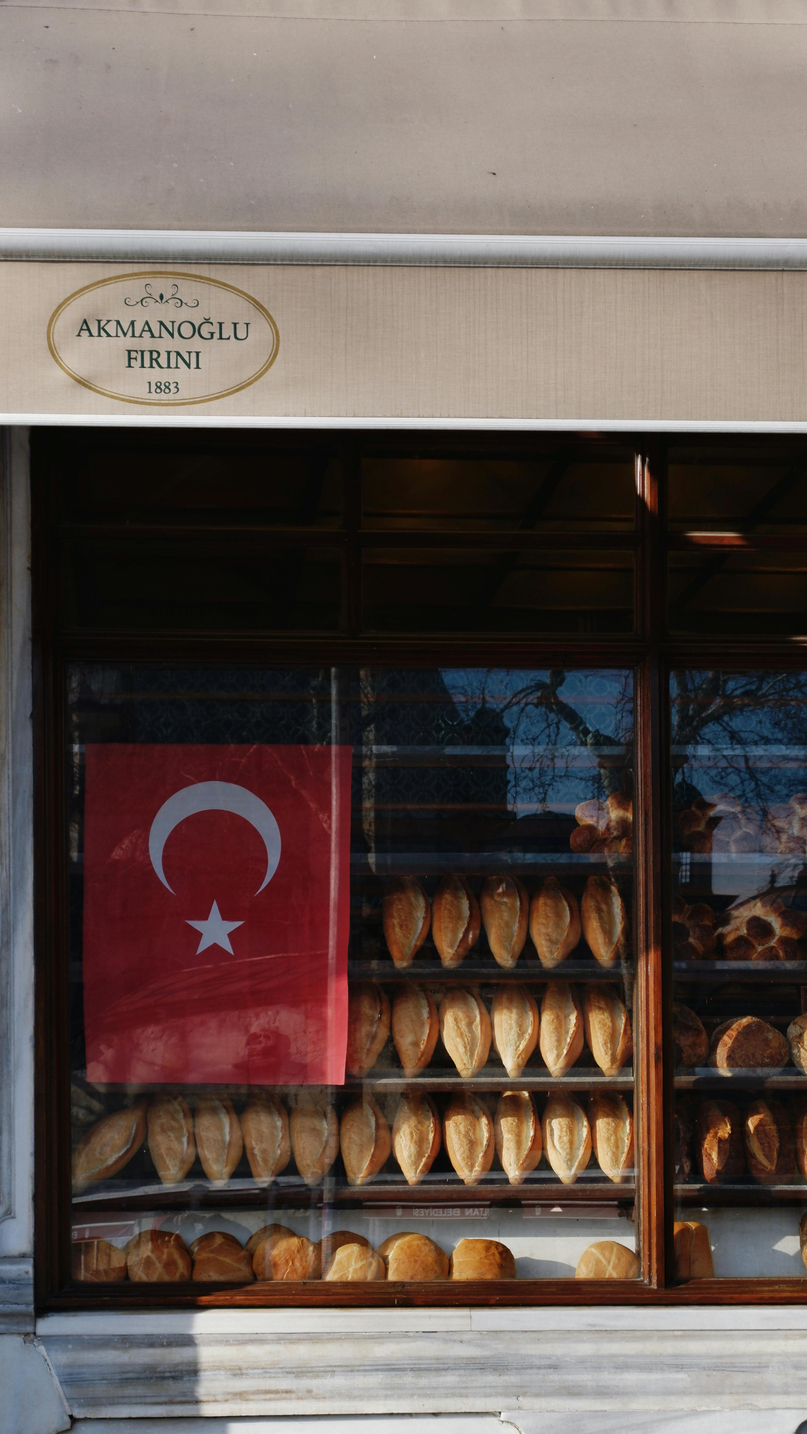Turkish Bakery Display with Bread and Flag · Free Stock Photo