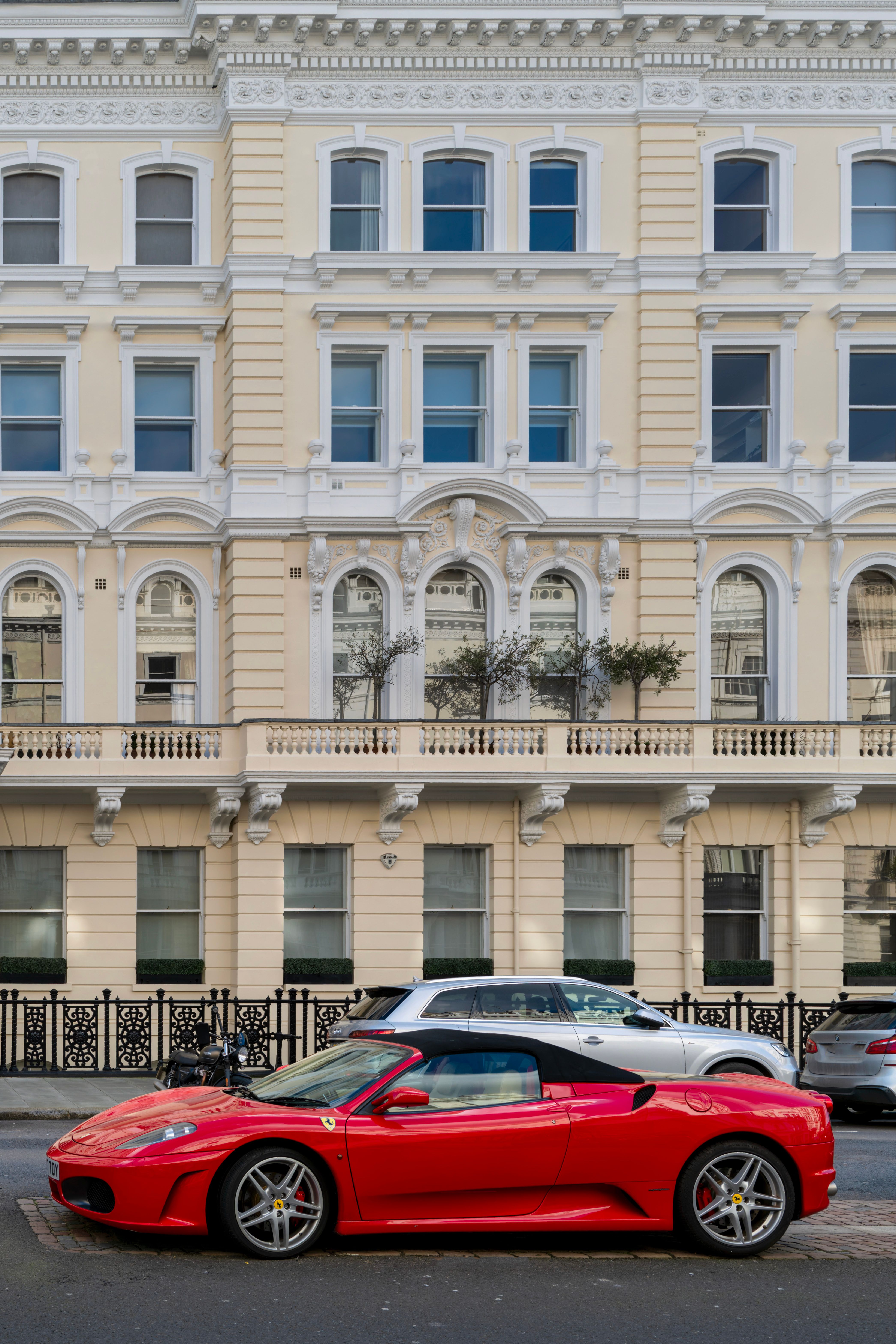 Luxury Red Ferrari Parked in Urban Setting · Free Stock Photo