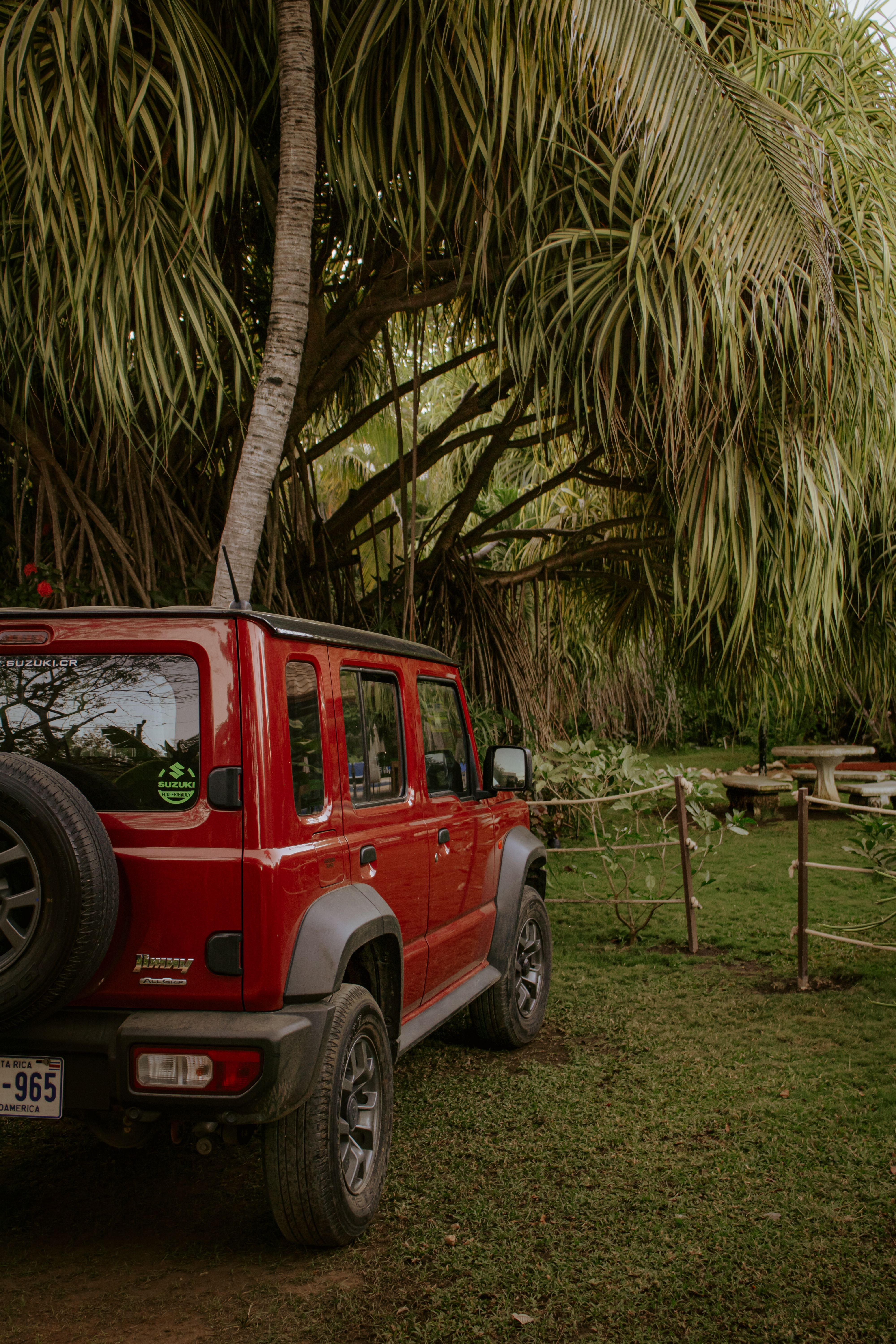 Red Jeep Under Lush Tropical Foliage in Costa Rica · Free Stock Photo