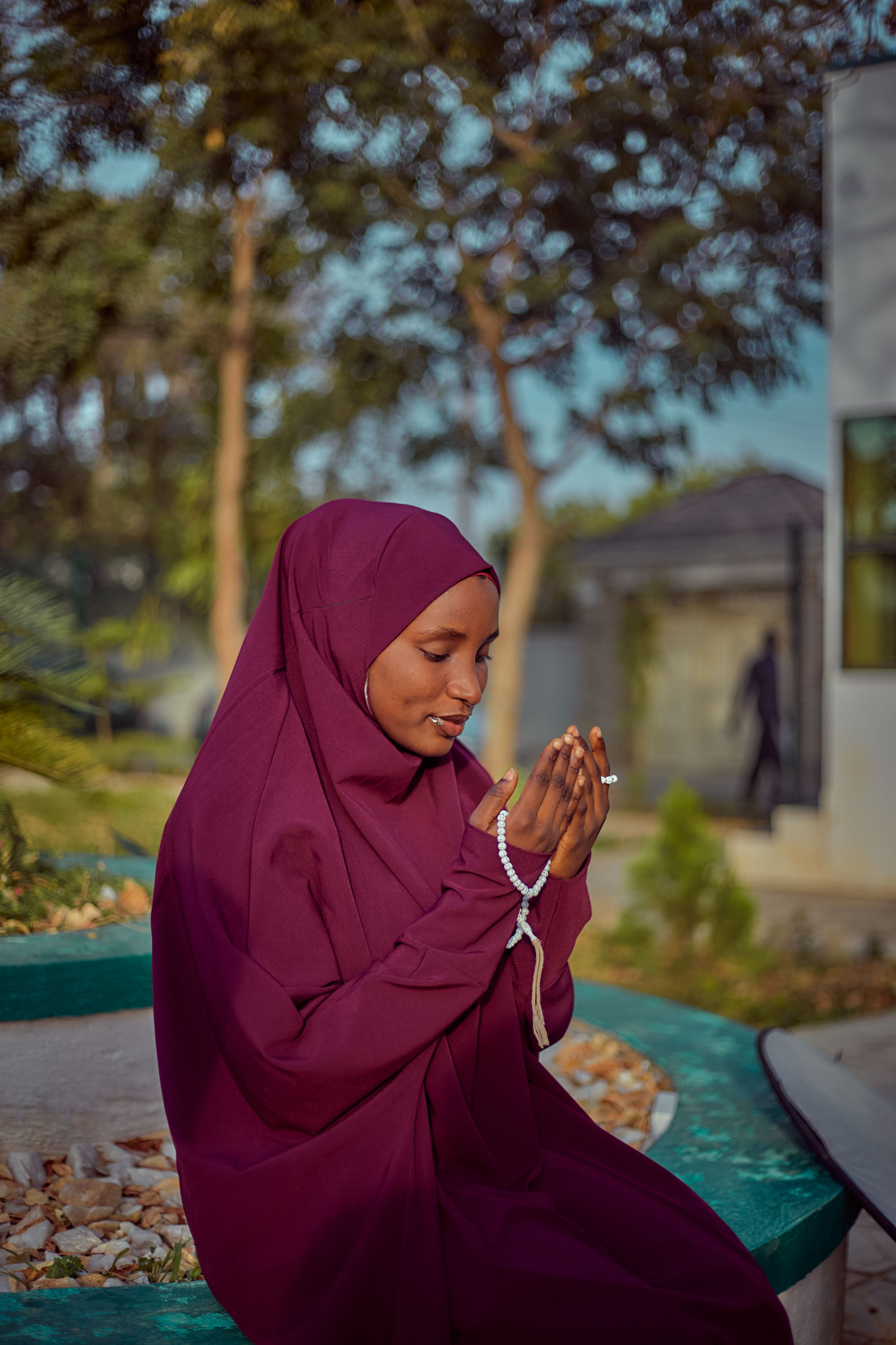 Woman in Hijab Praying Outdoors · Free Stock Photo