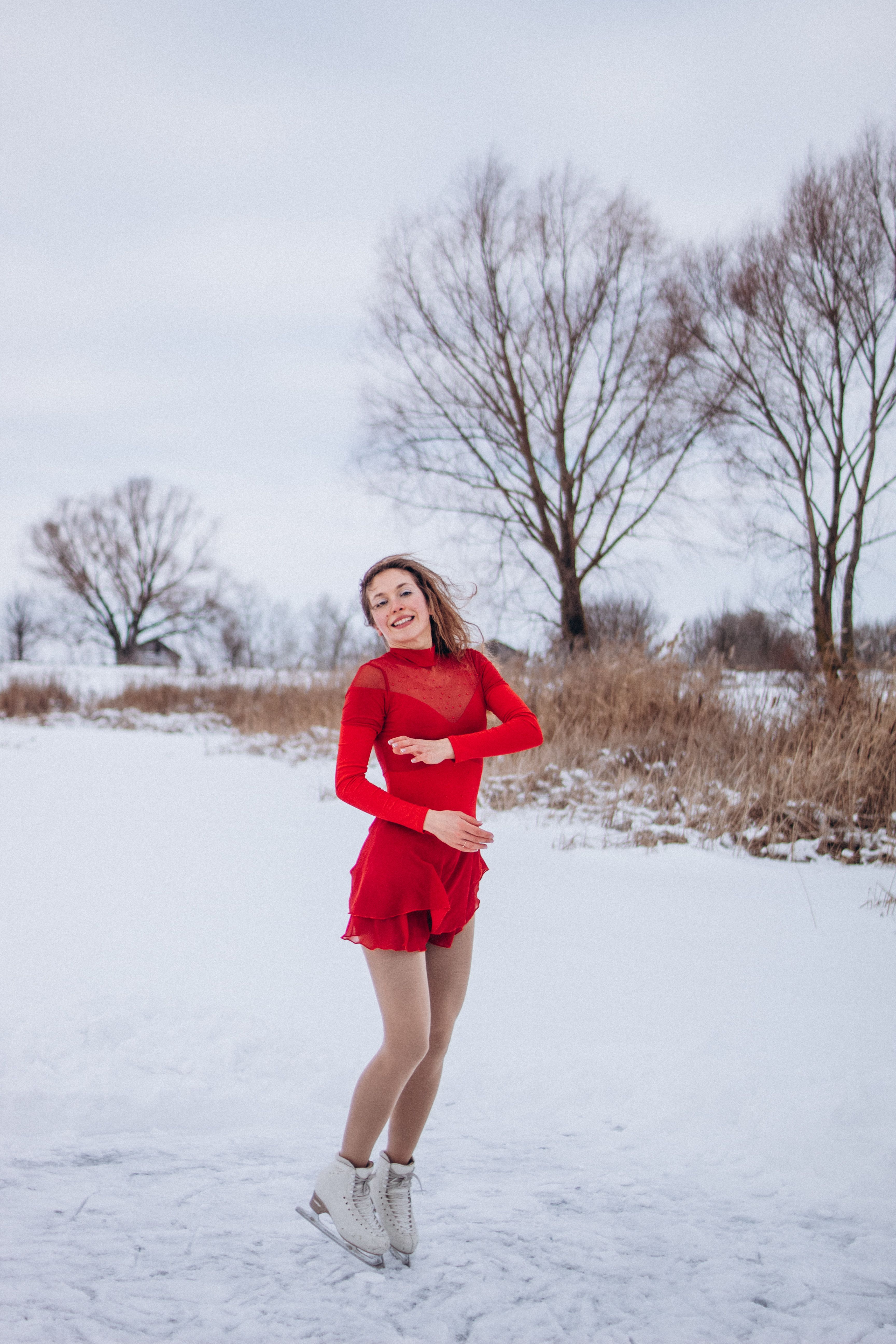 Elegant Ice Skating Performance in Winter Landscape · Free Stock Photo