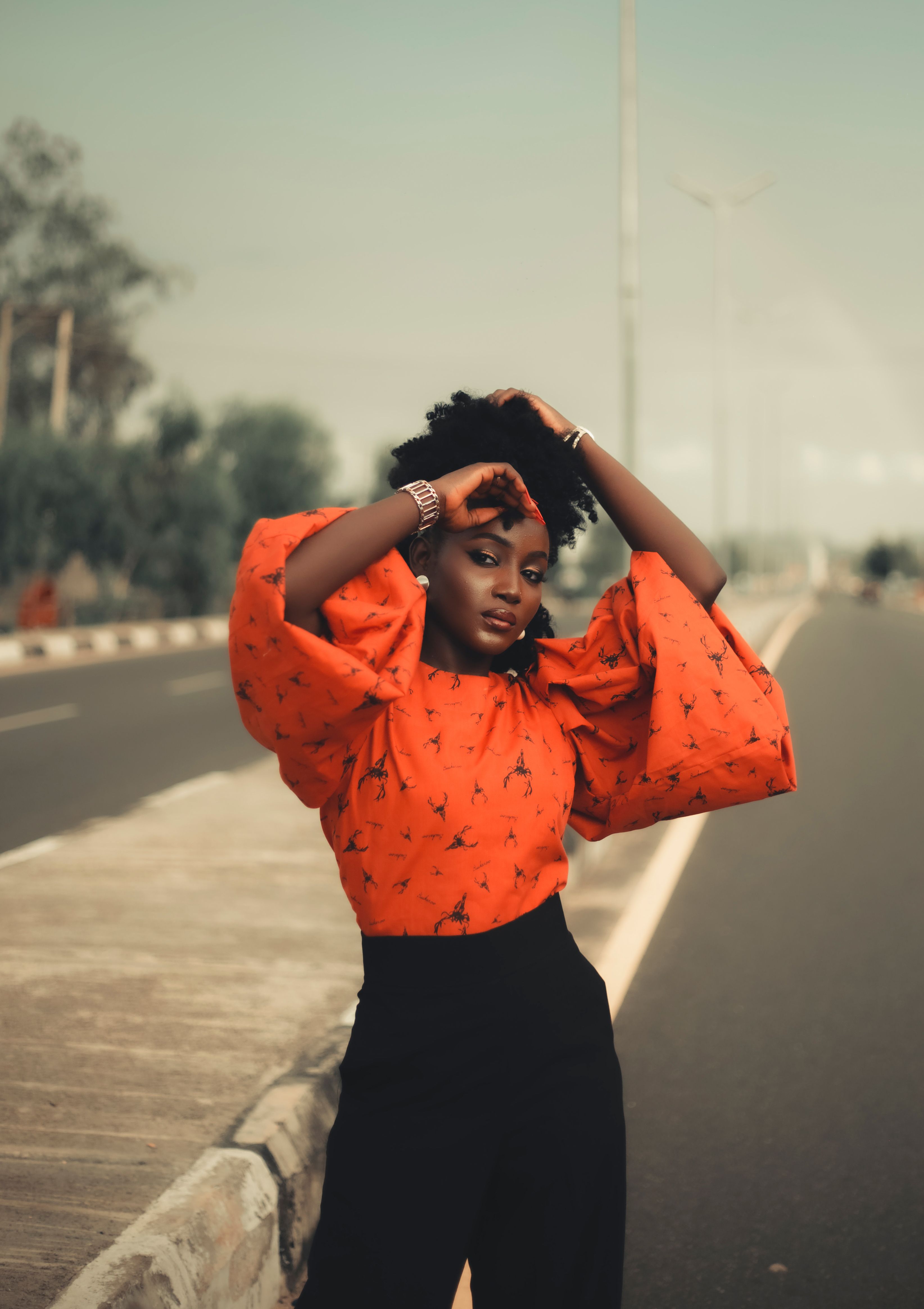 Stylish Woman Posing on Urban Roadside · Free Stock Photo