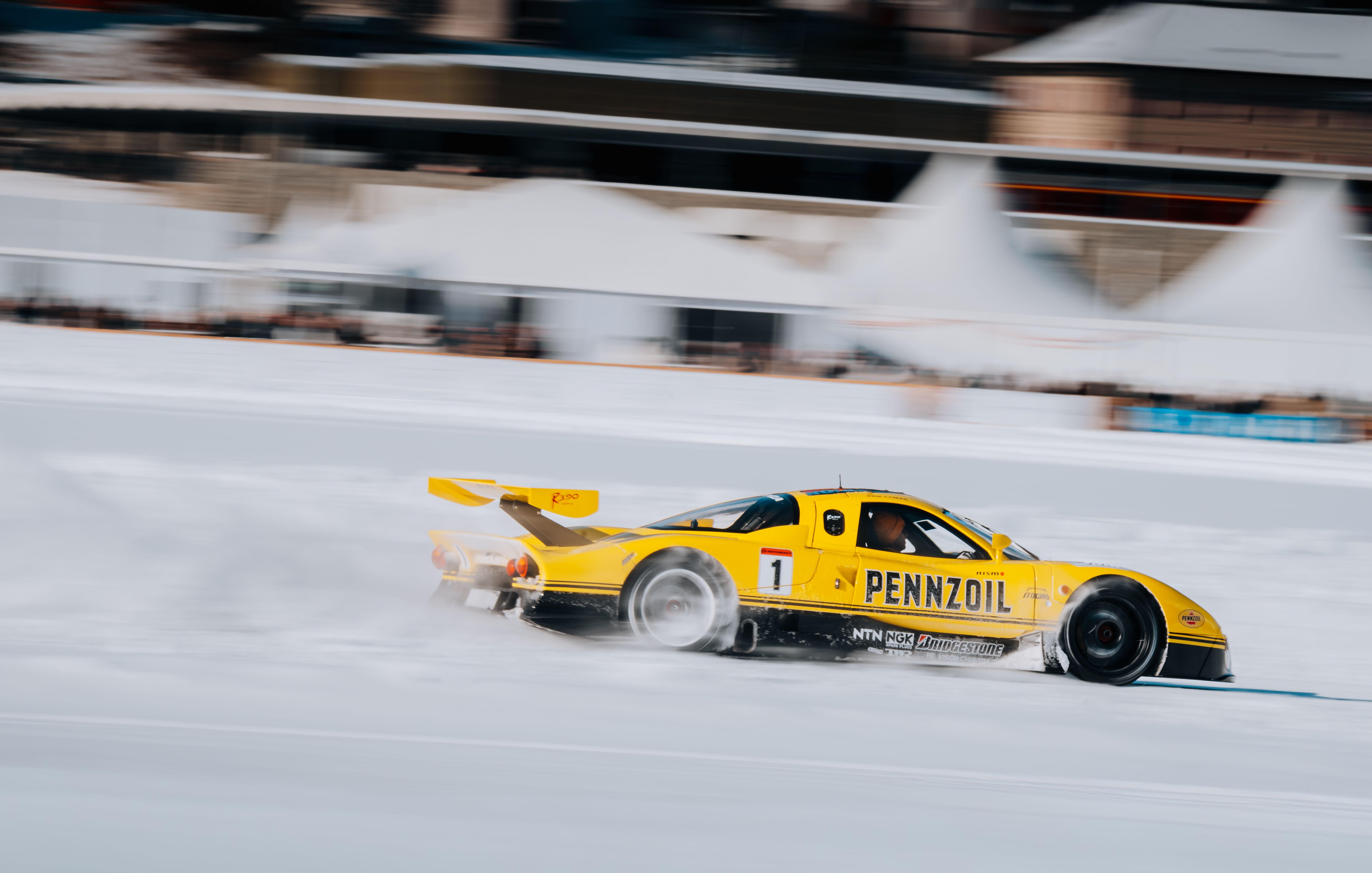 Yellow Racing Car Drifting on Snowy Track · Free Stock Photo
