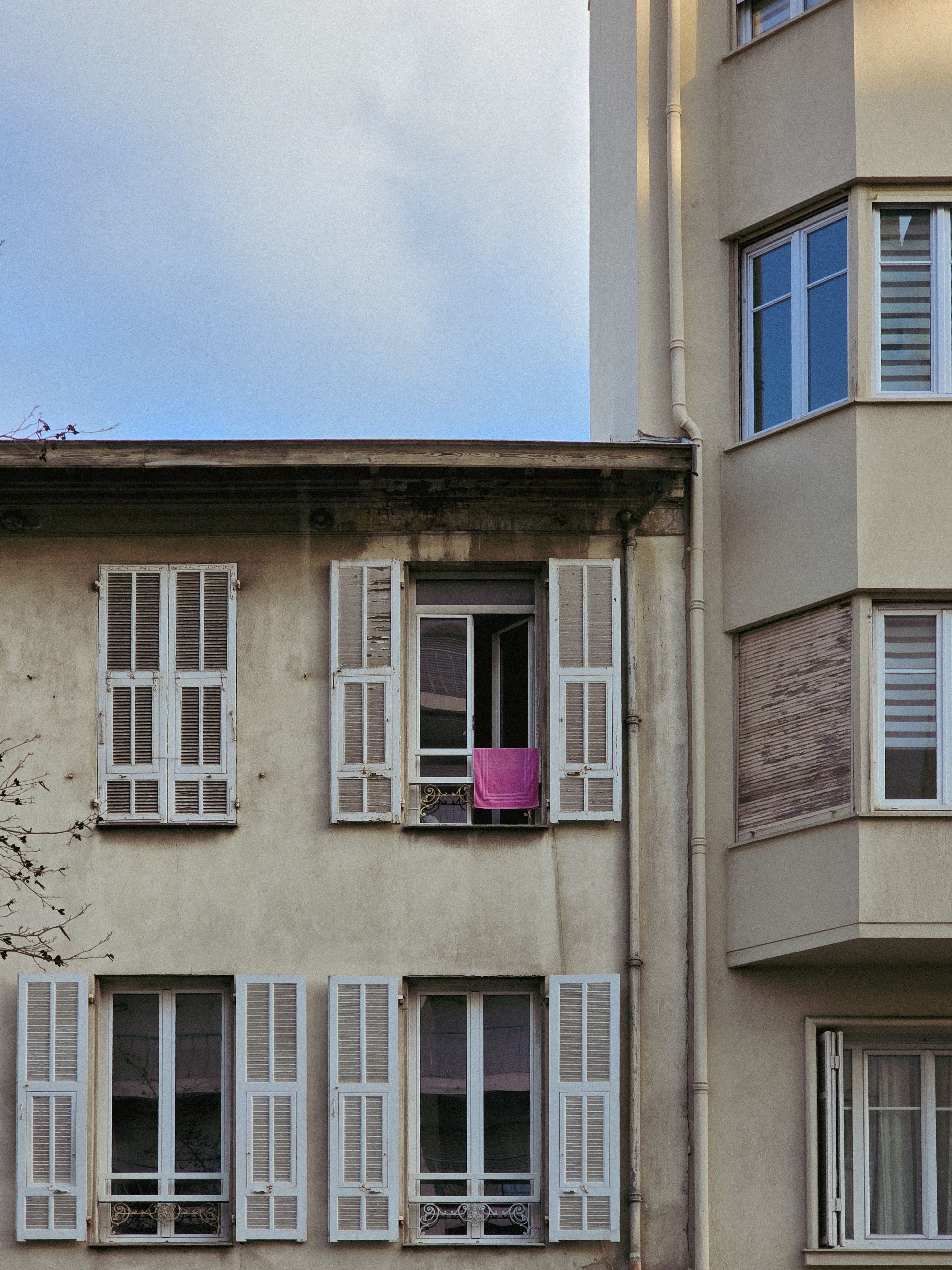 Person On a Window of an Apartment Building · Free Stock Photo