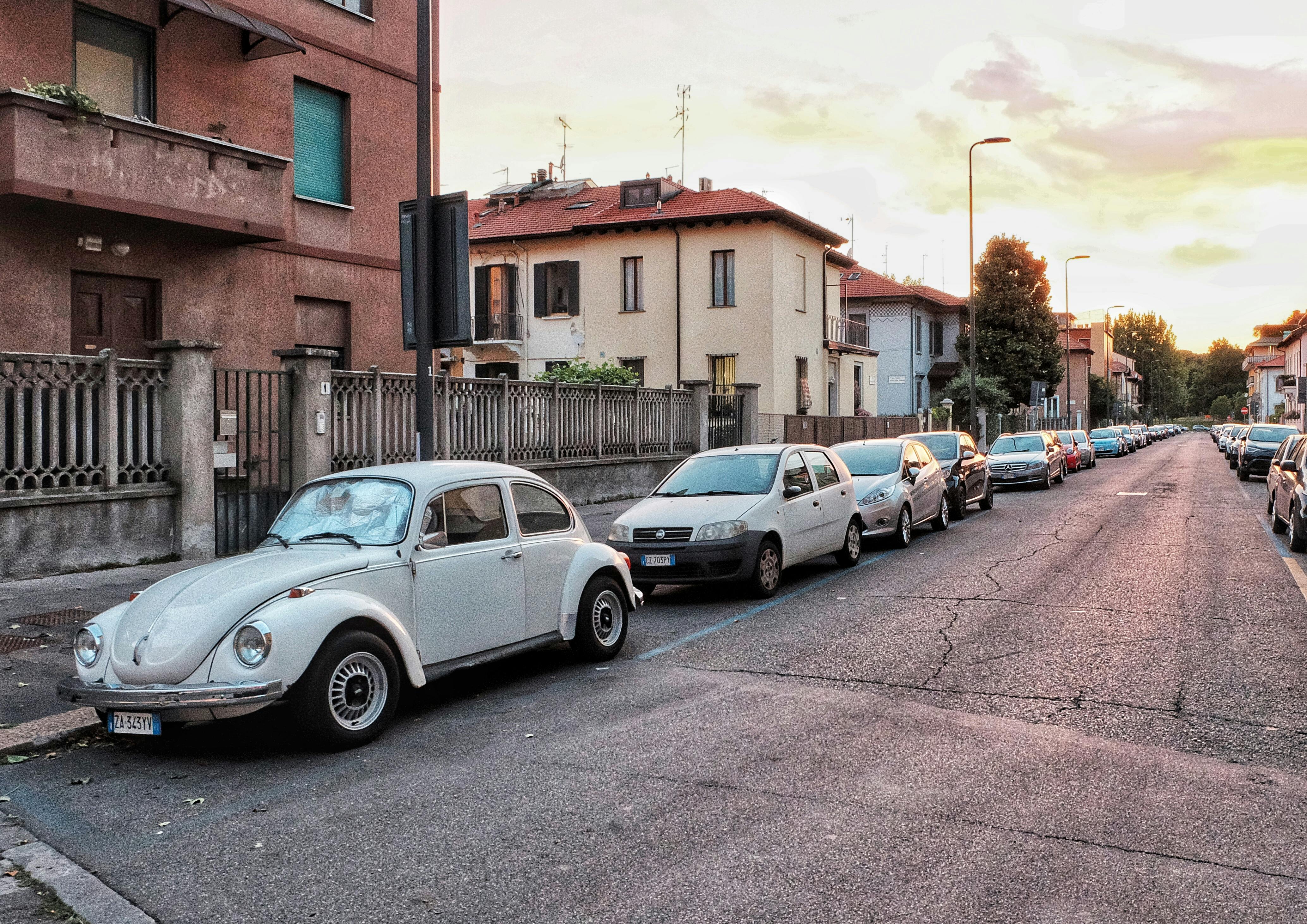 Retro car driving along narrow road in historic city · Free Stock Photo