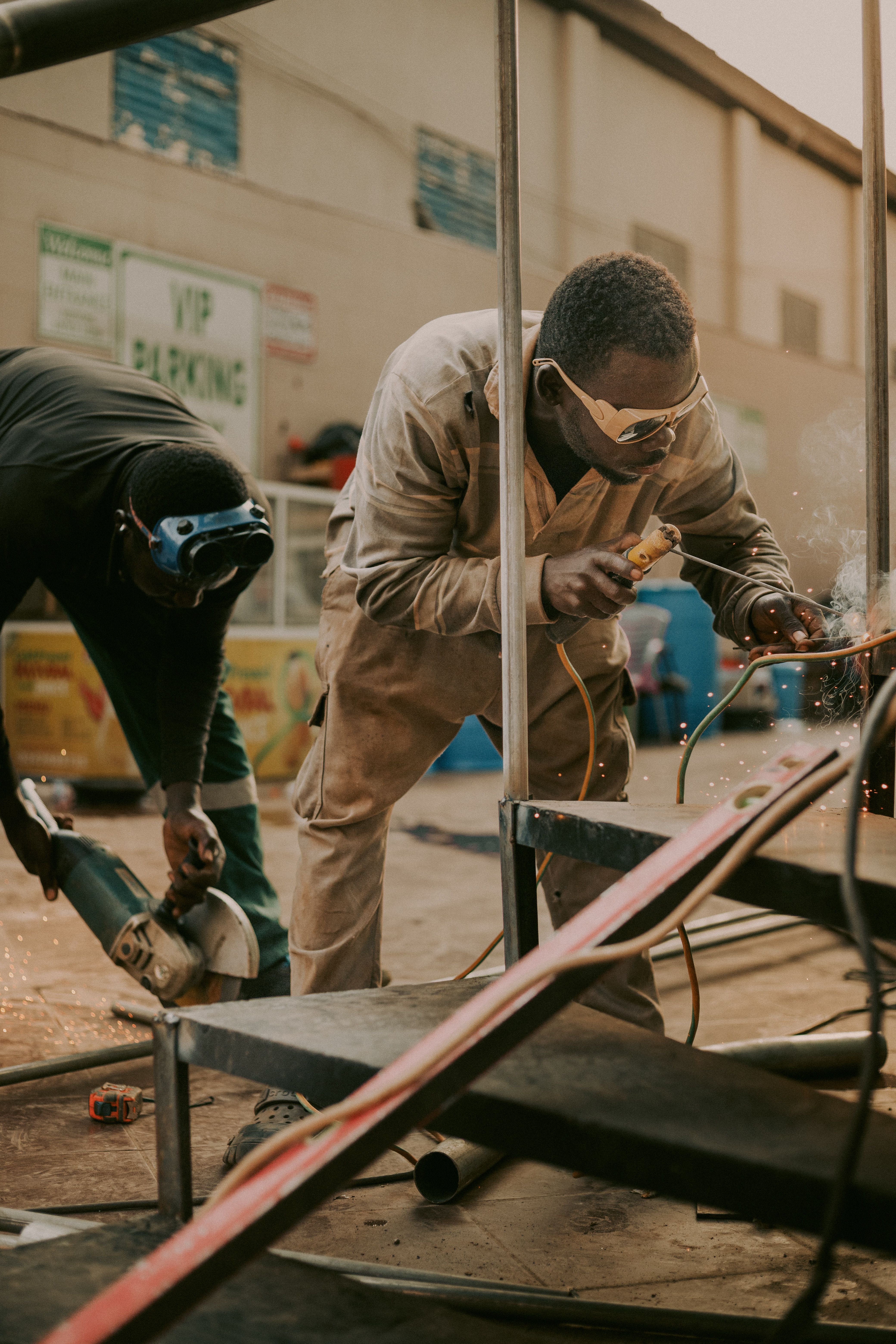 Industrial Workers Welding Metal Structure Outdoors · Free Stock Photo