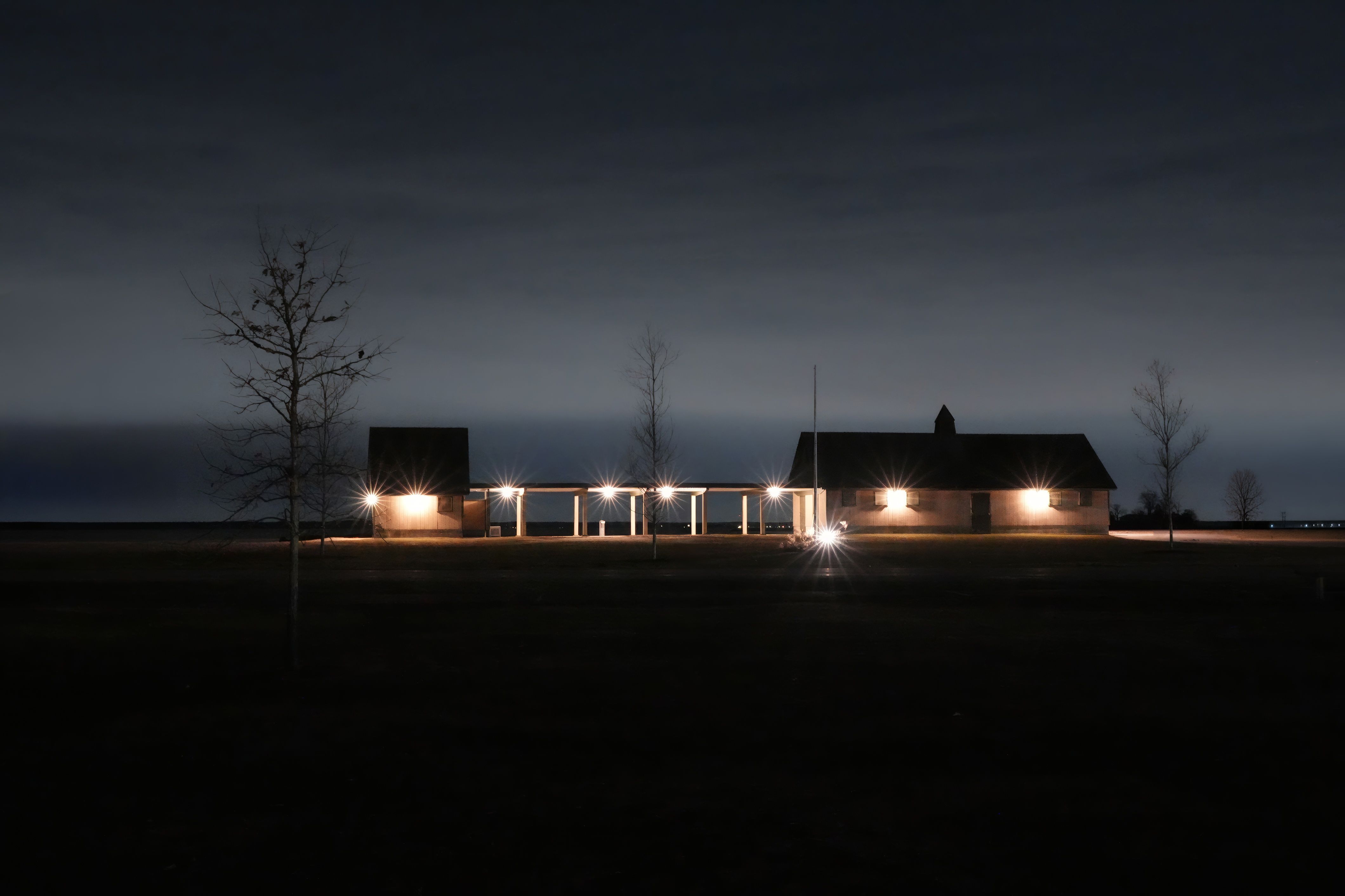 Illuminated Building at Night in Open Field · Free Stock Photo