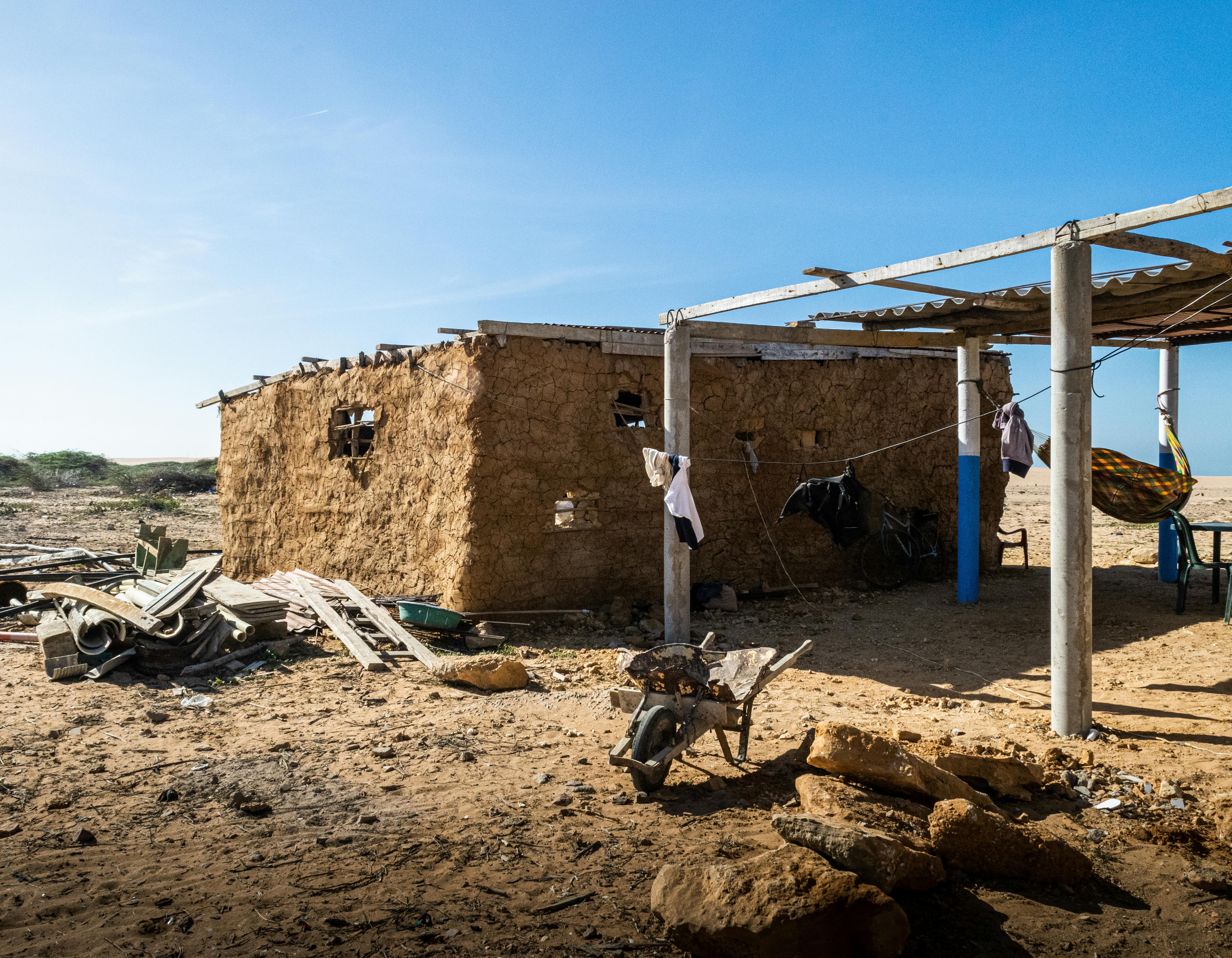 An Unfinished House on Brown Field Under Blue Sky · Free Stock Photo