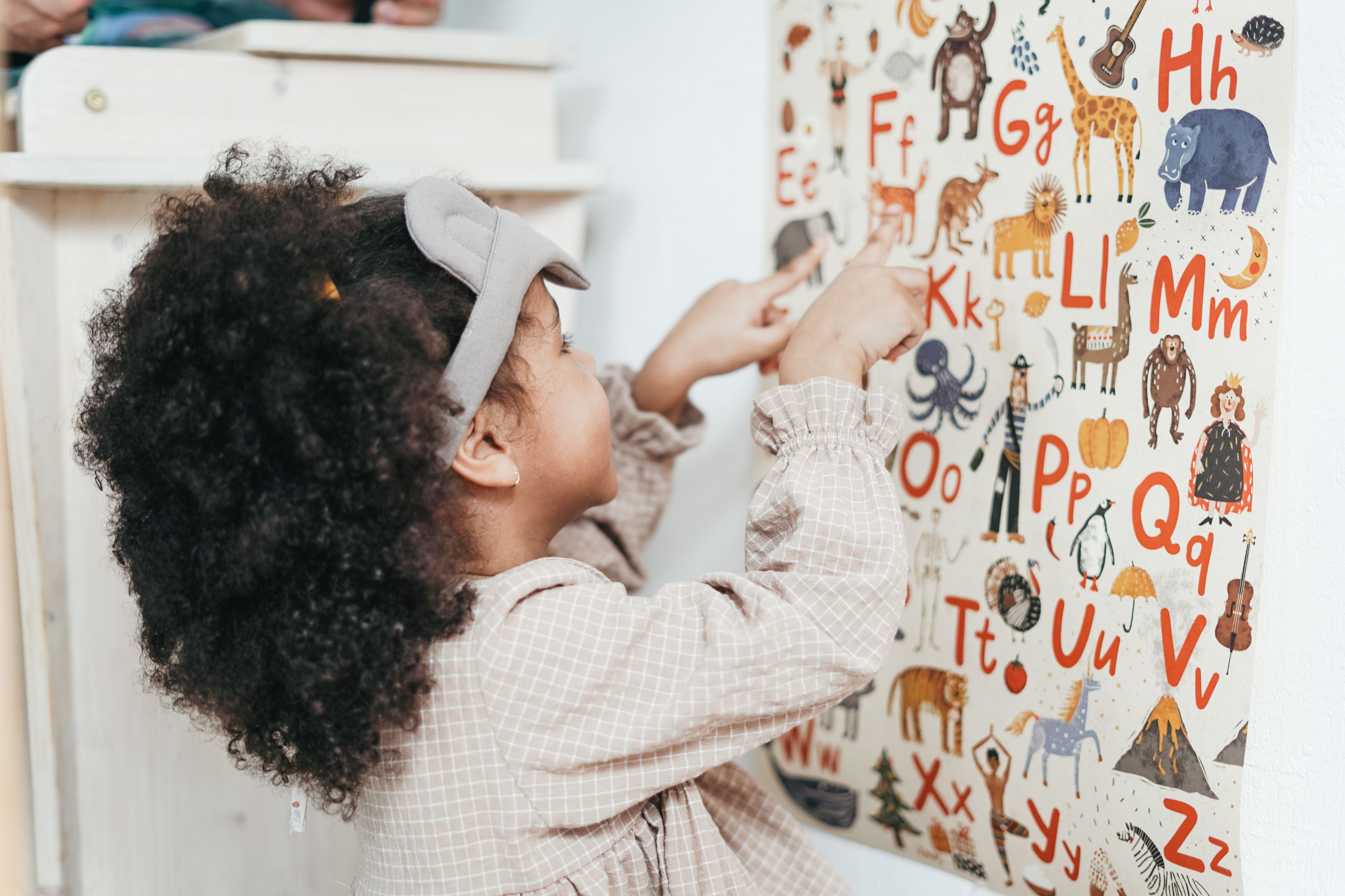 Girl Pointing on Alphabets · Free Stock Photo