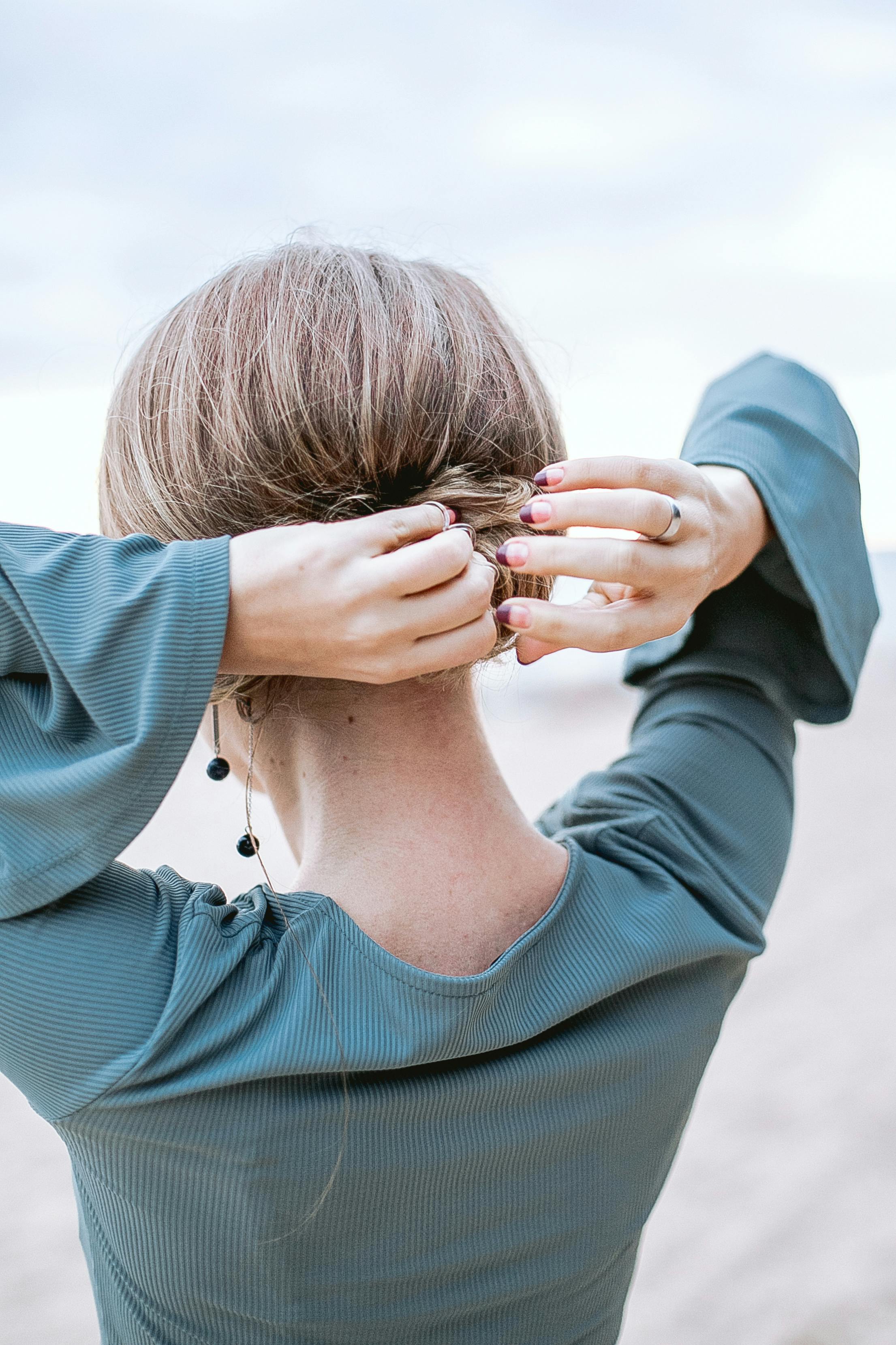 Photo of a Person Fixing Her Hair · Free Stock Photo