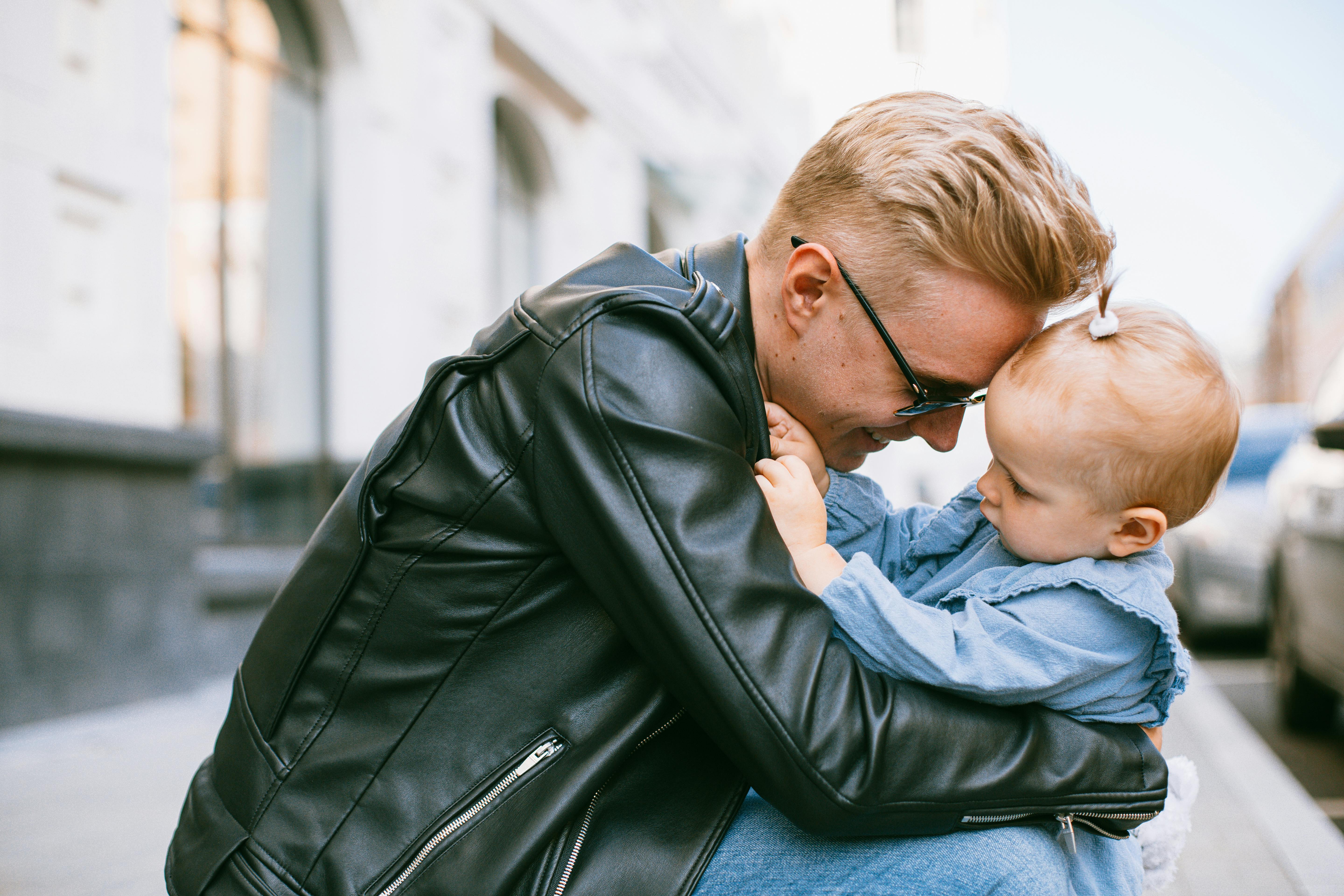 Photo Of Man Carrying Newborn Baby · Free Stock Photo