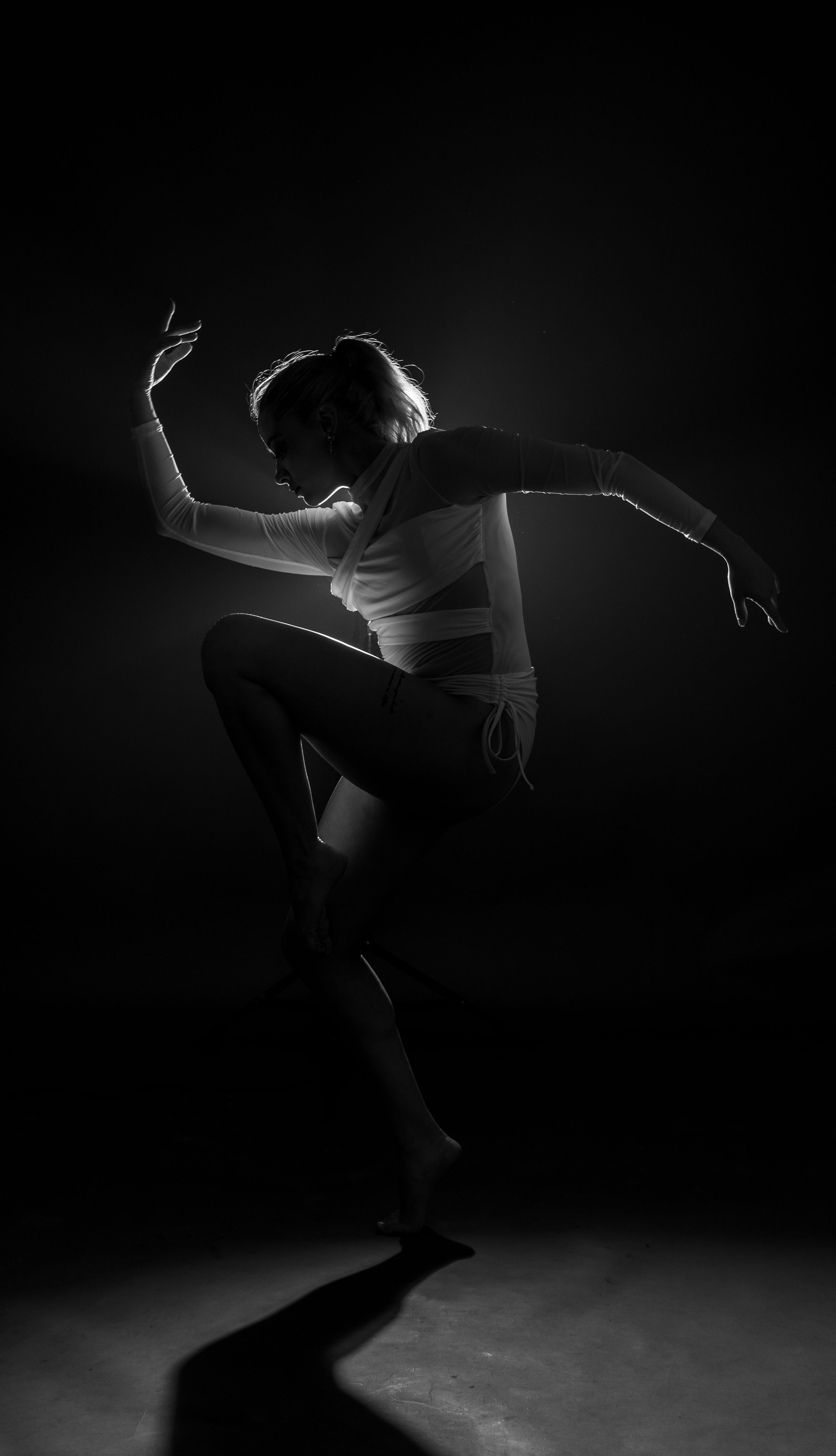 Elegant Ballet Dancer in Dramatic Backlight Pose · Free Stock Photo