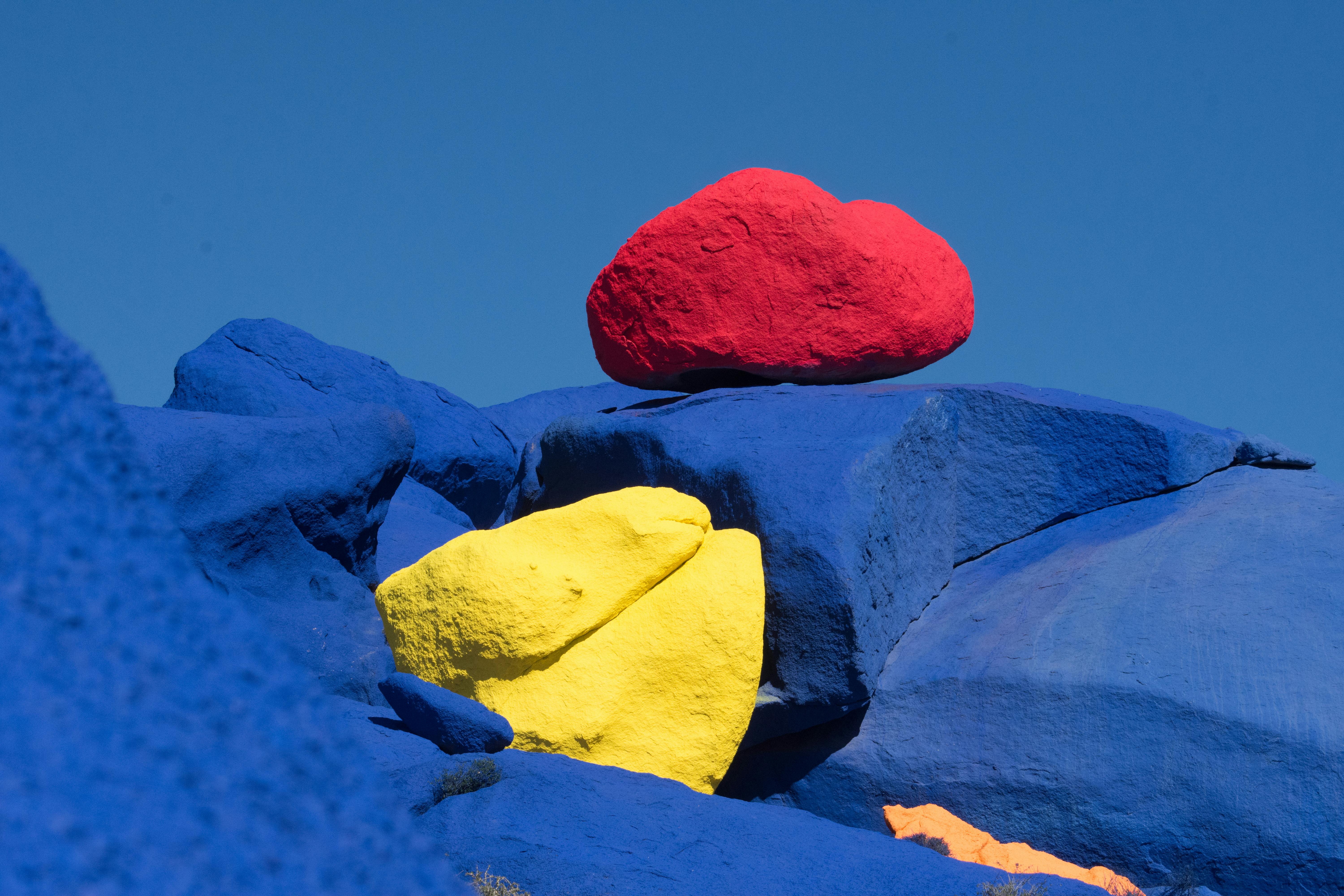 Yellow and Red Stone on Blue Rocks · Free Stock Photo