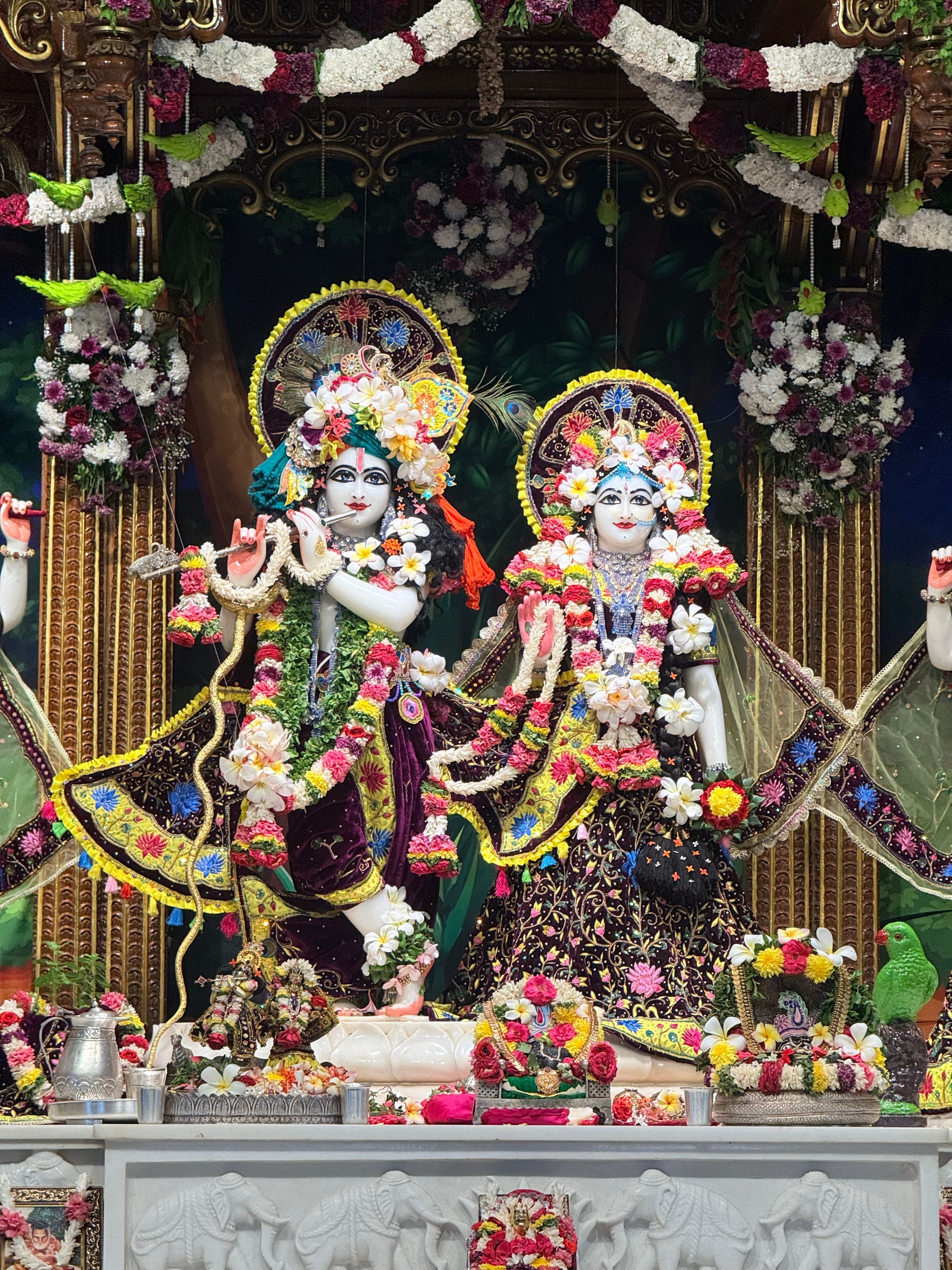 Vibrant Hindu Deity Statue Decorated with Flowers · Free Stock Photo