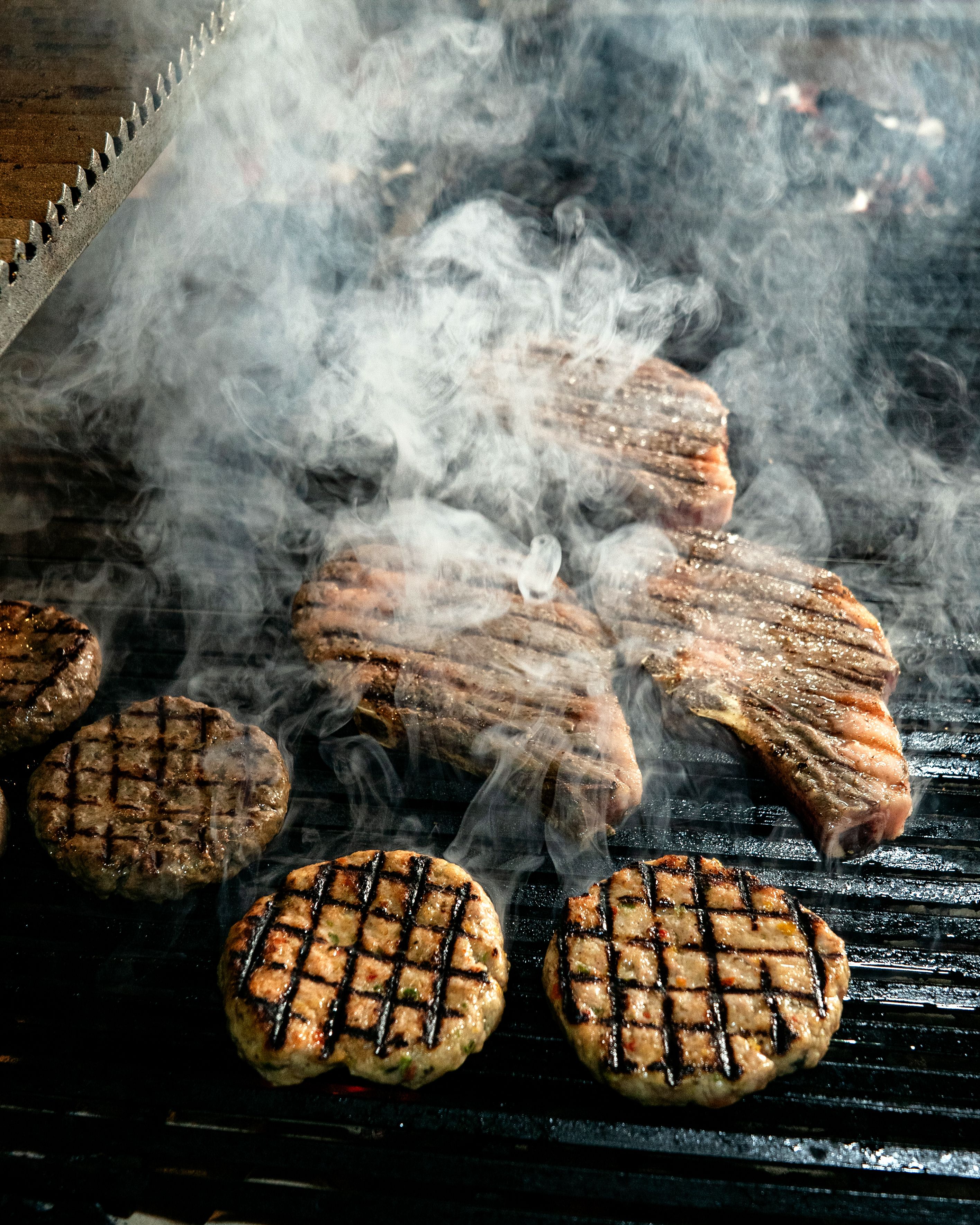 Juicy Grilled Steaks and Burgers Sizzling · Free Stock Photo