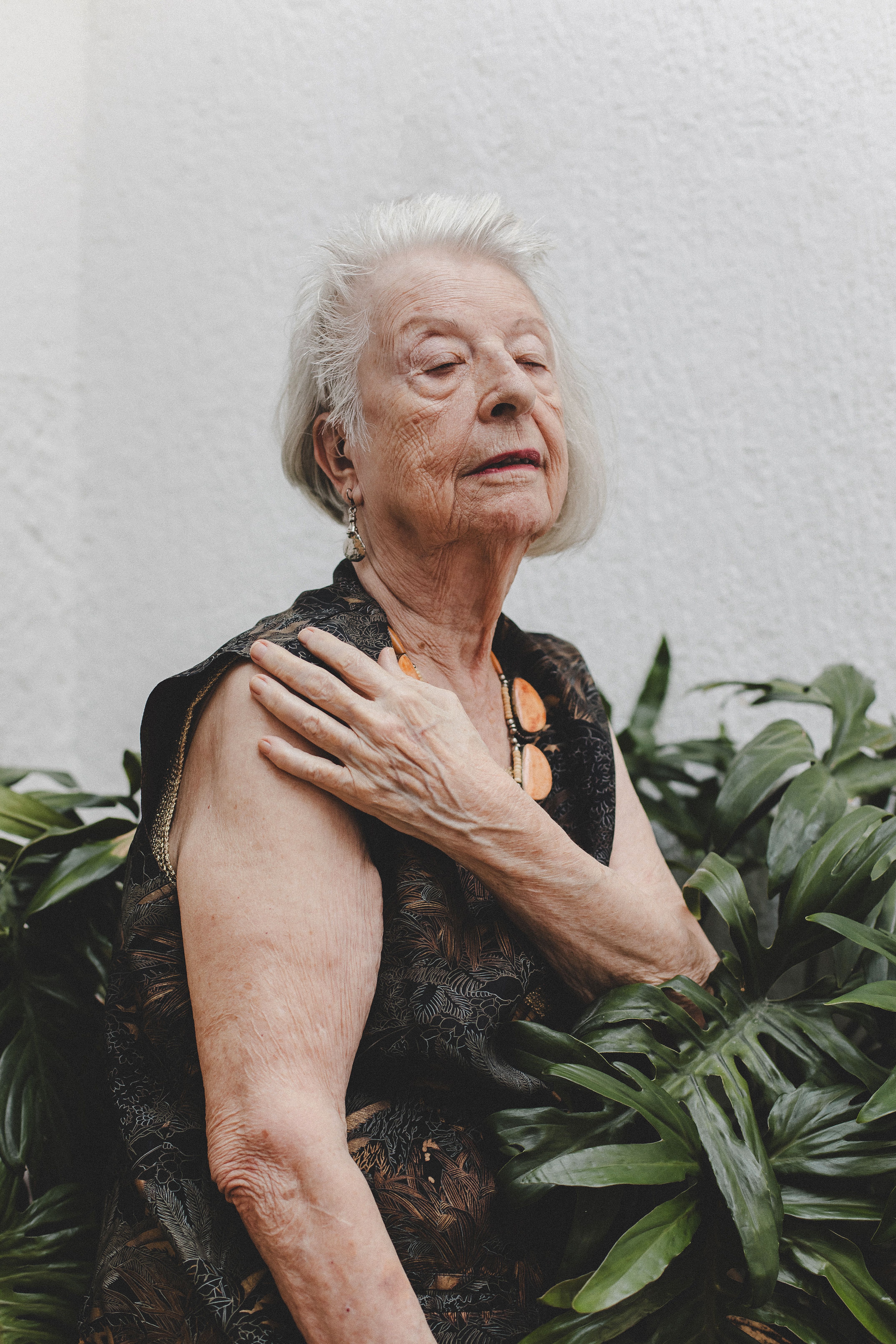 Smiling Elderly Woman in Garden Setting · Free Stock Photo