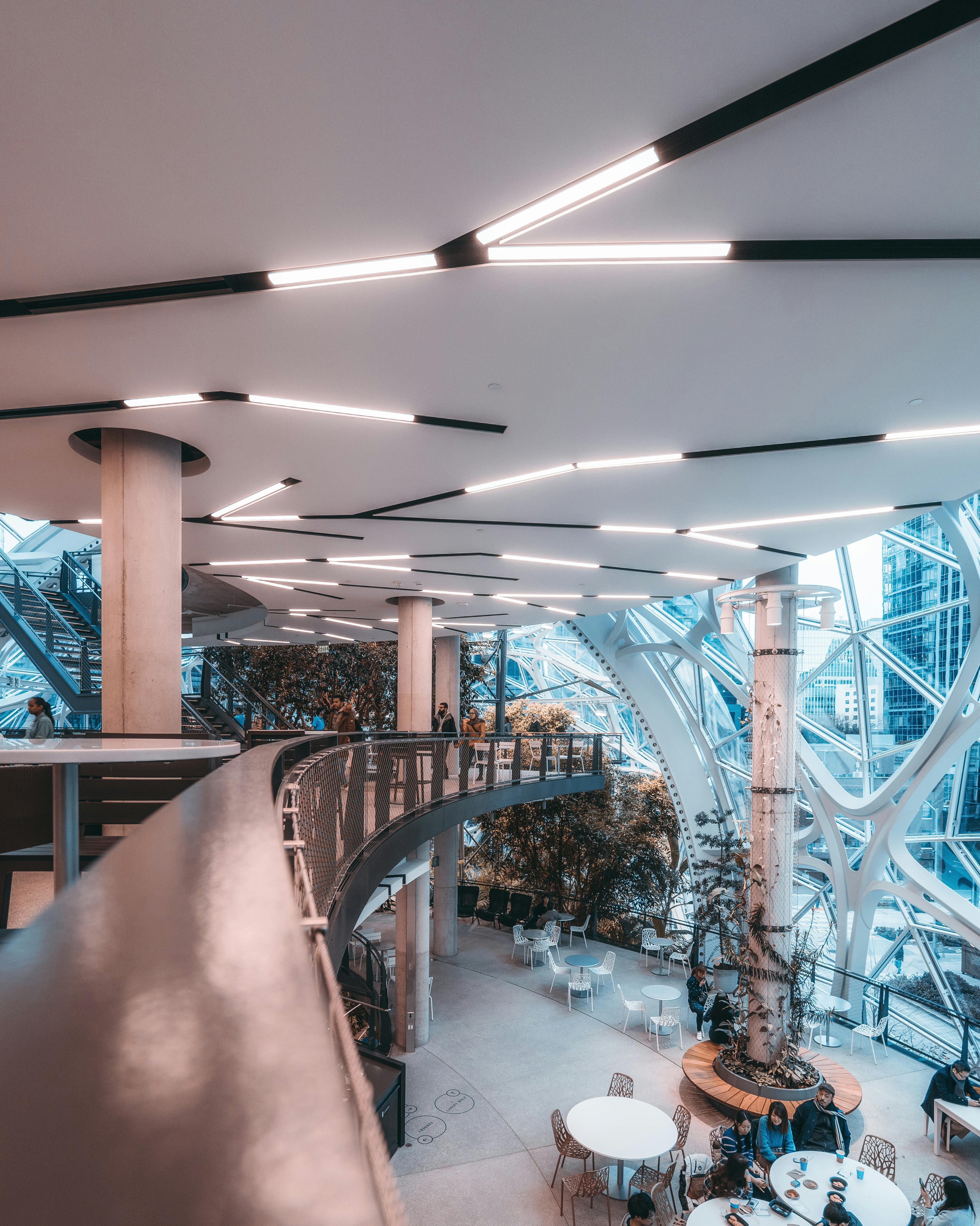 People Walking Inside Building With Glass Walls · Free Stock Photo