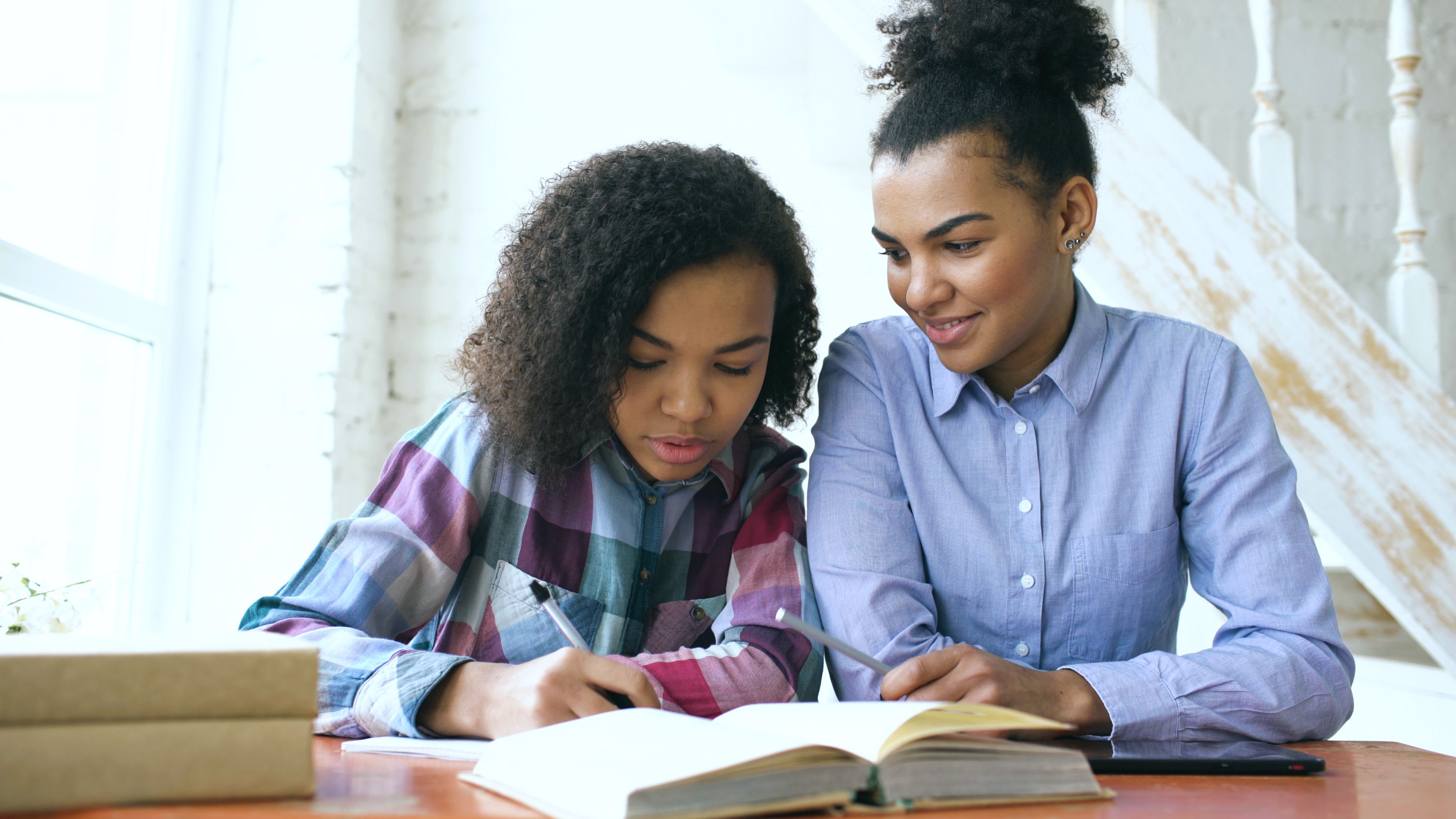 Teen tutoring session at home study table · Free Stock Photo