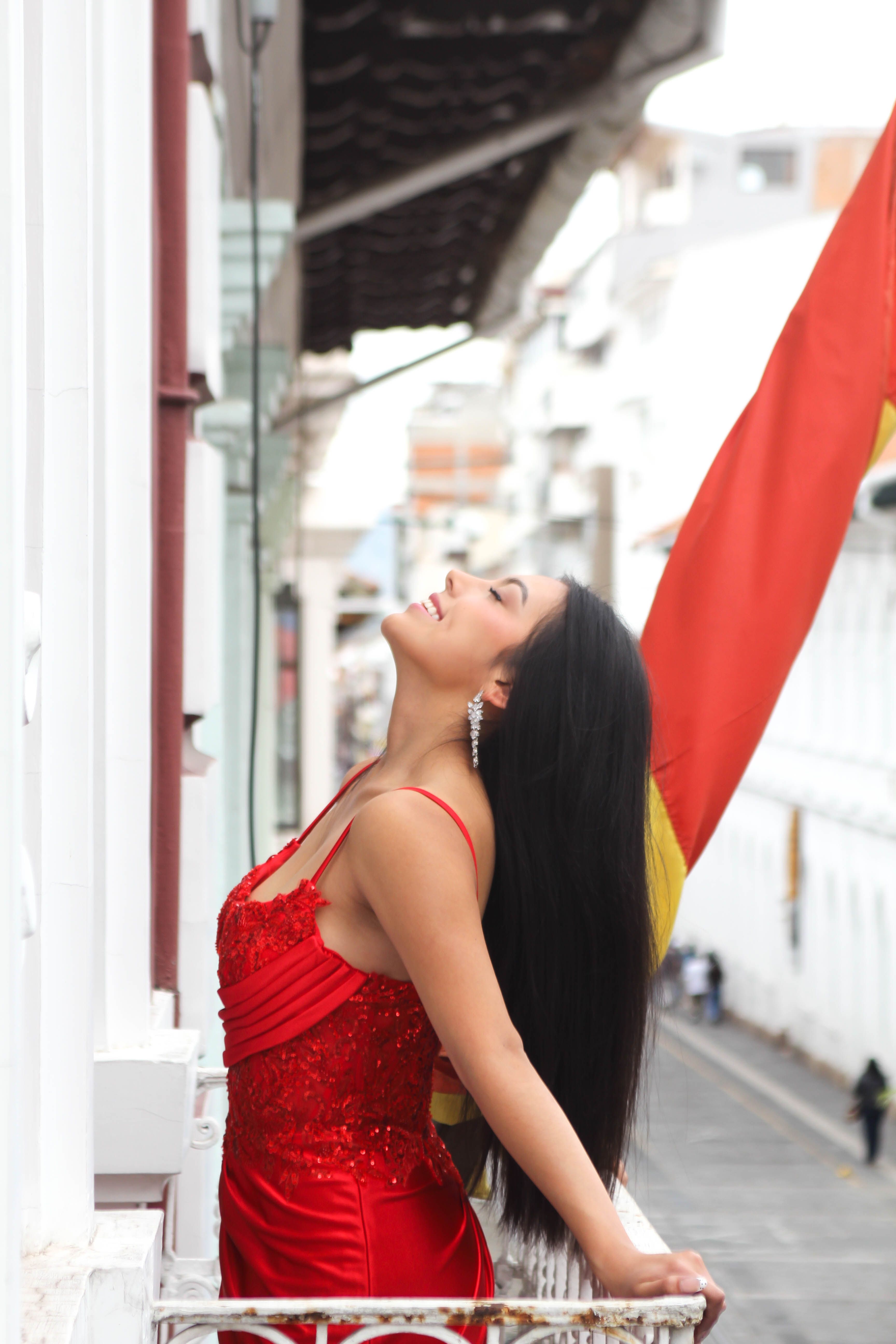 Elegant Woman in Red Dress on Ornate Balcony · Free Stock Photo
