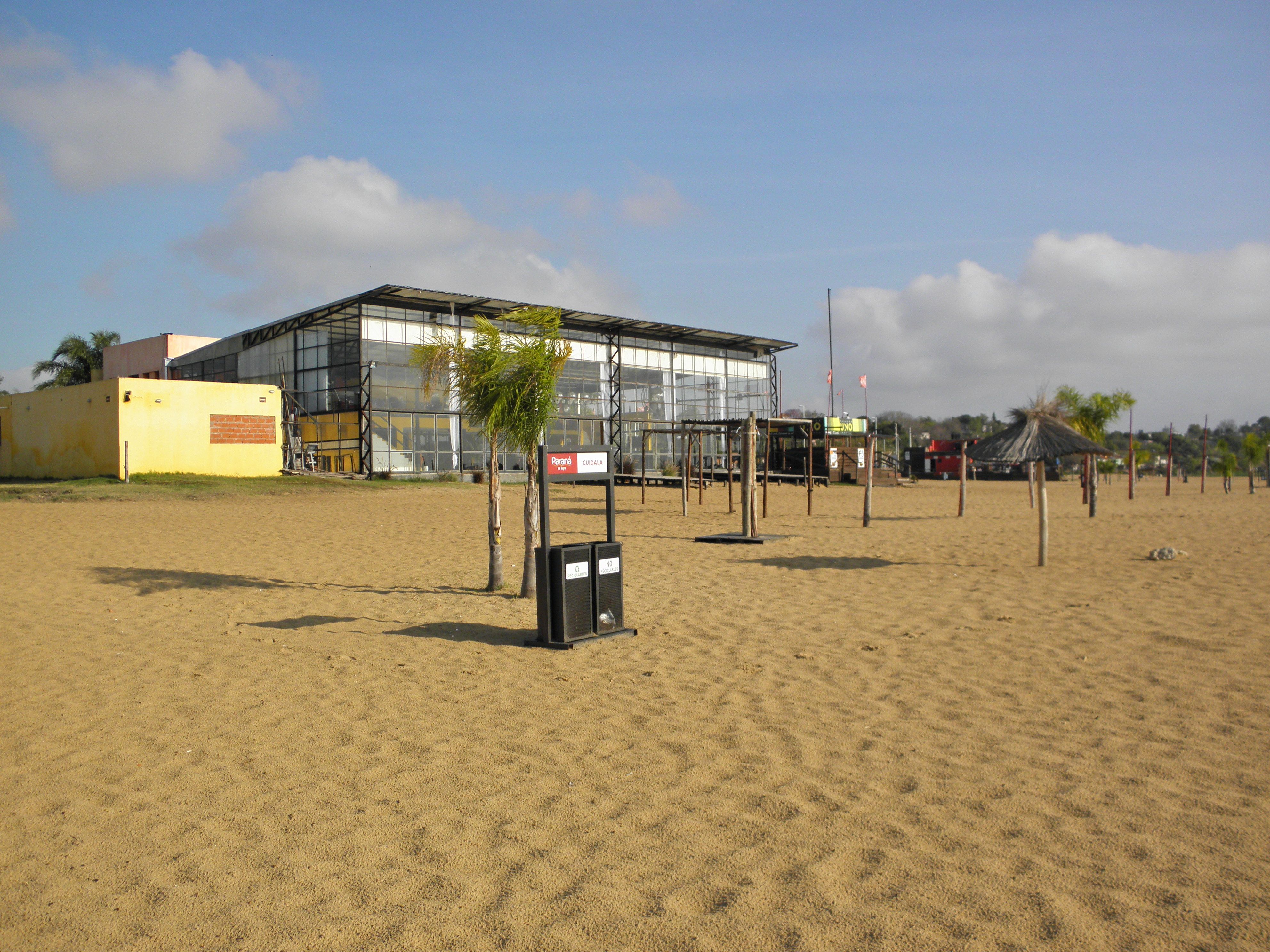Modern Glass Building on Sandy Beach · Free Stock Photo