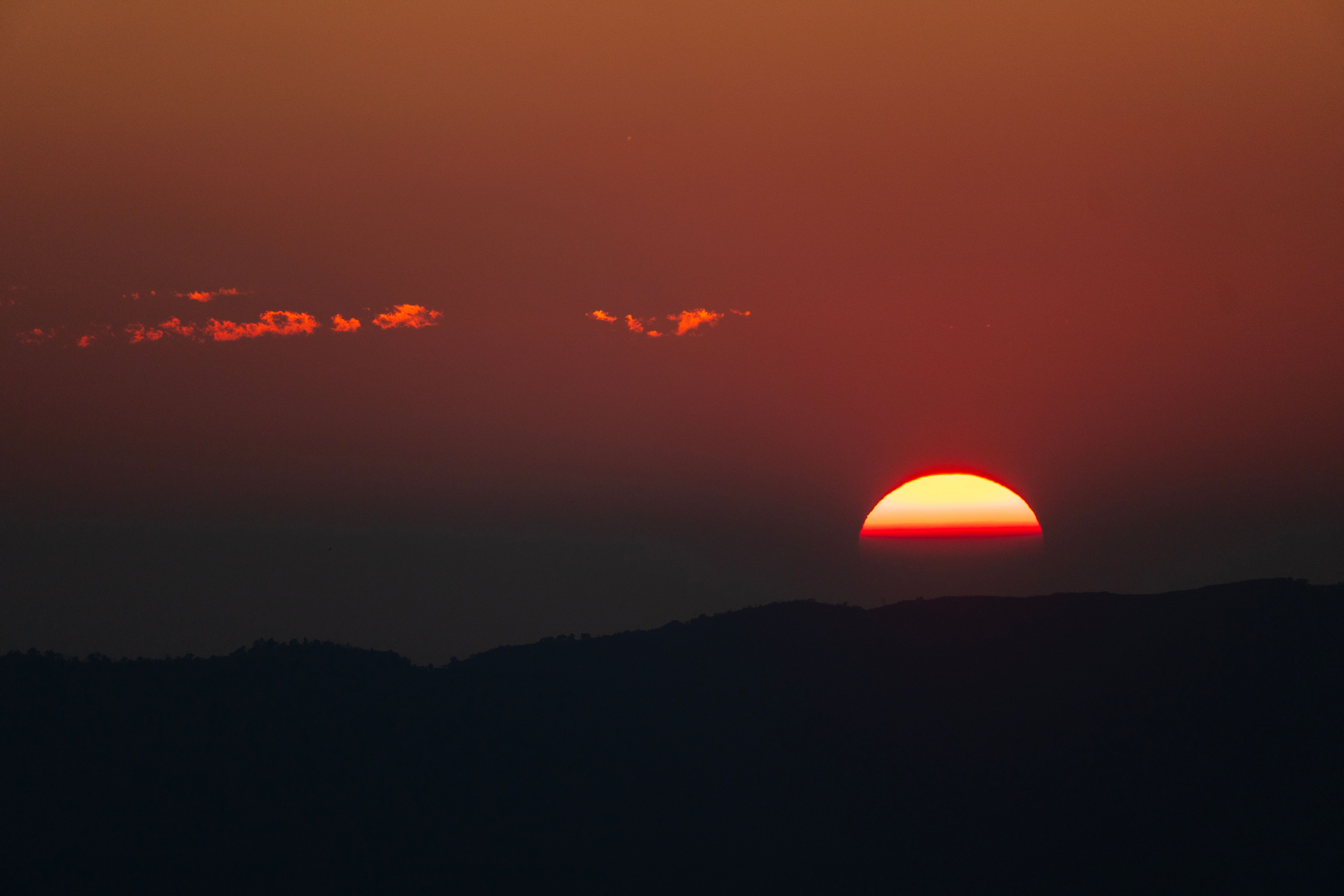 Stunning Red Sunset Over Mountain Horizon · Free Stock Photo