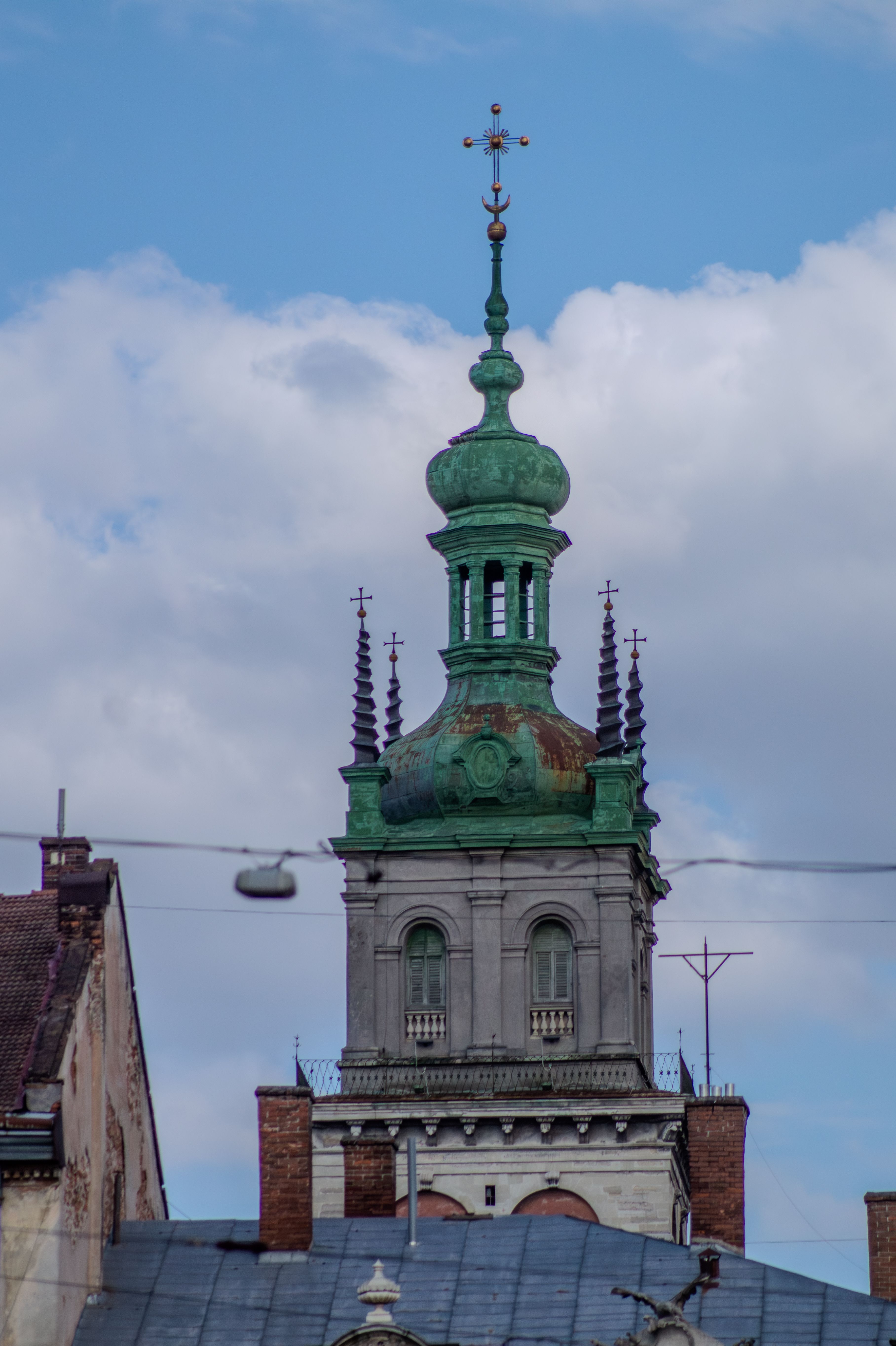 Historic Spire Against Blue Sky in Lviv · Free Stock Photo