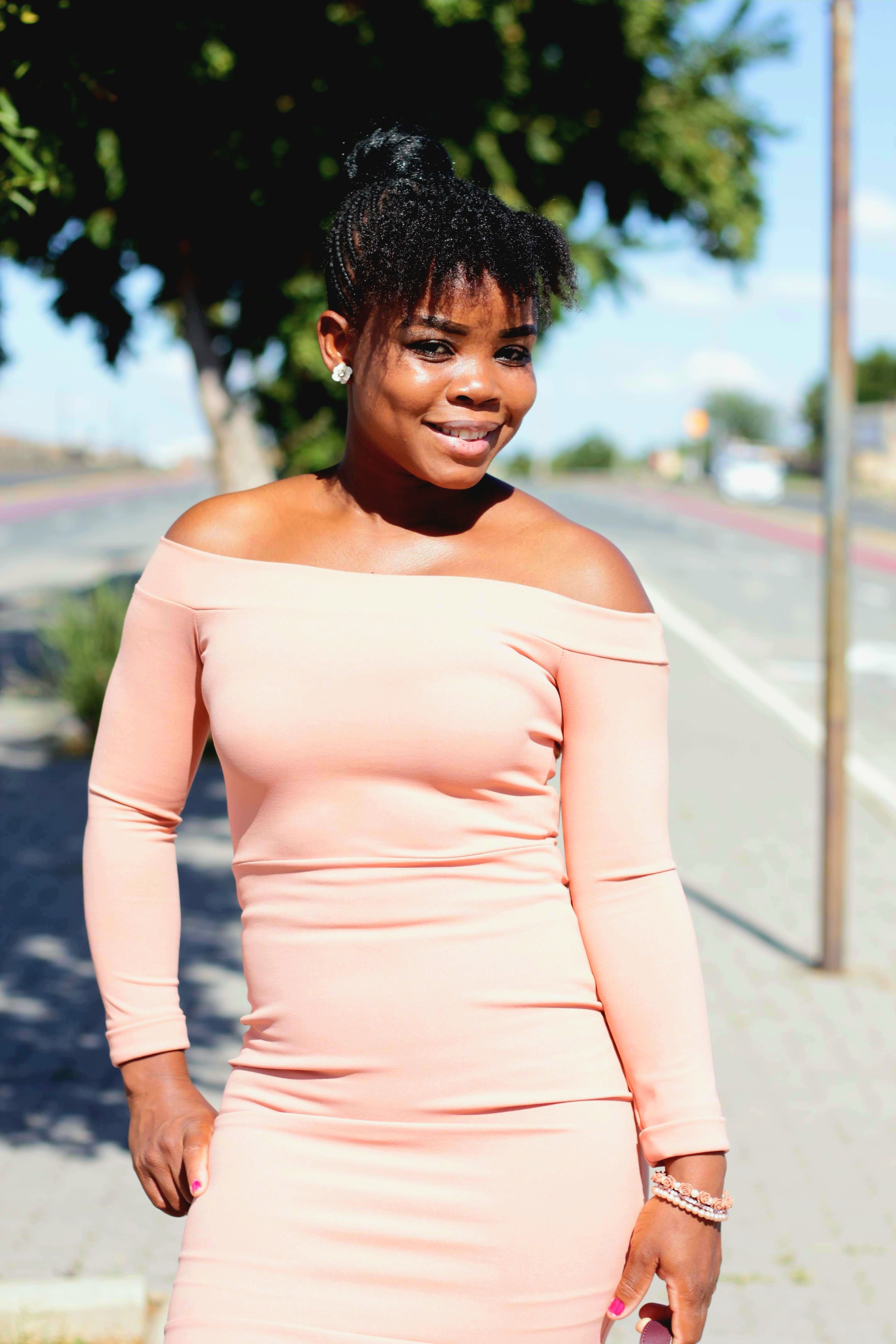 Smiling Woman in Pink Dress Posing Outdoors · Free Stock Photo