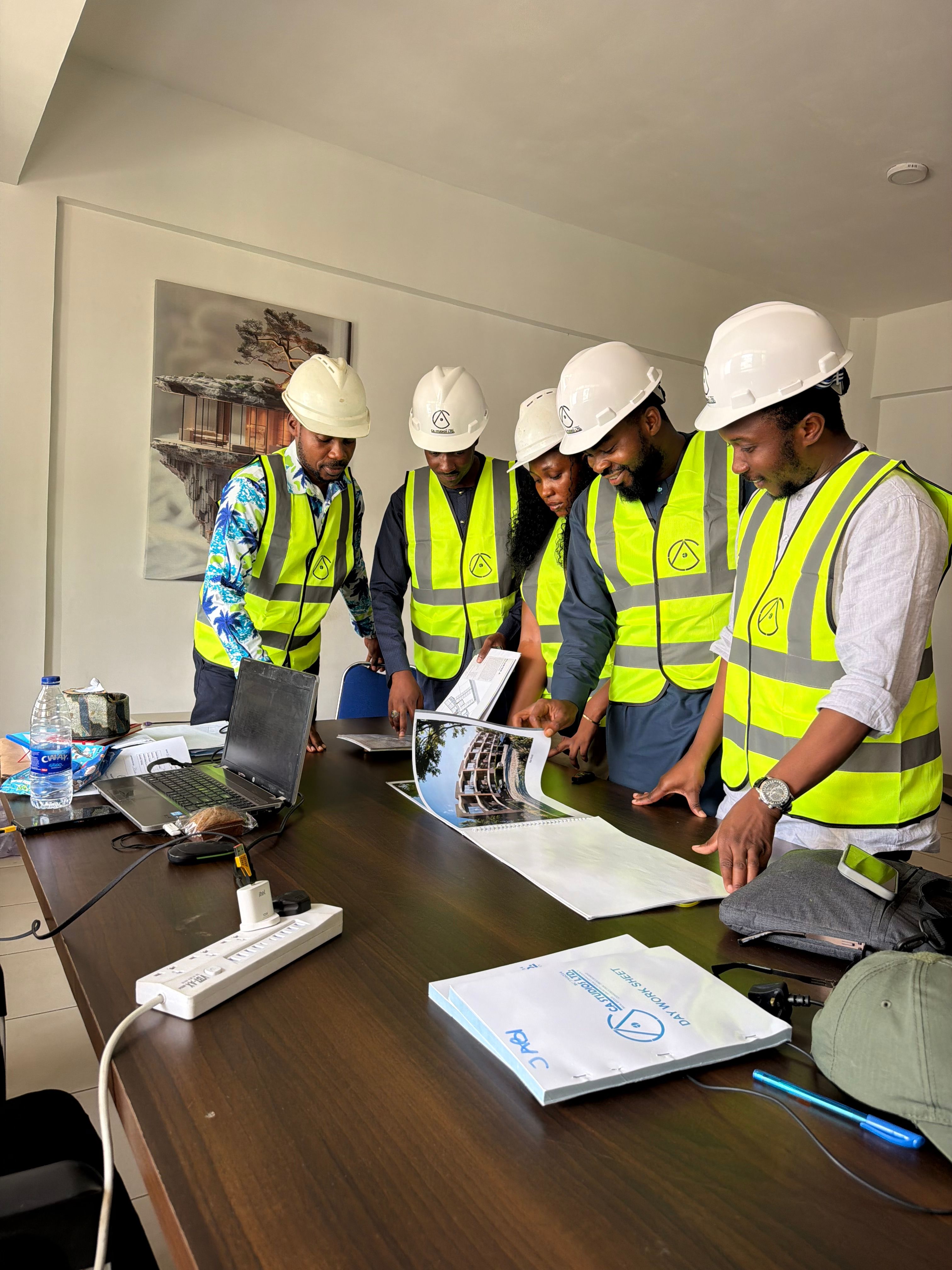 Team of Engineers Reviewing Building Plans · Free Stock Photo