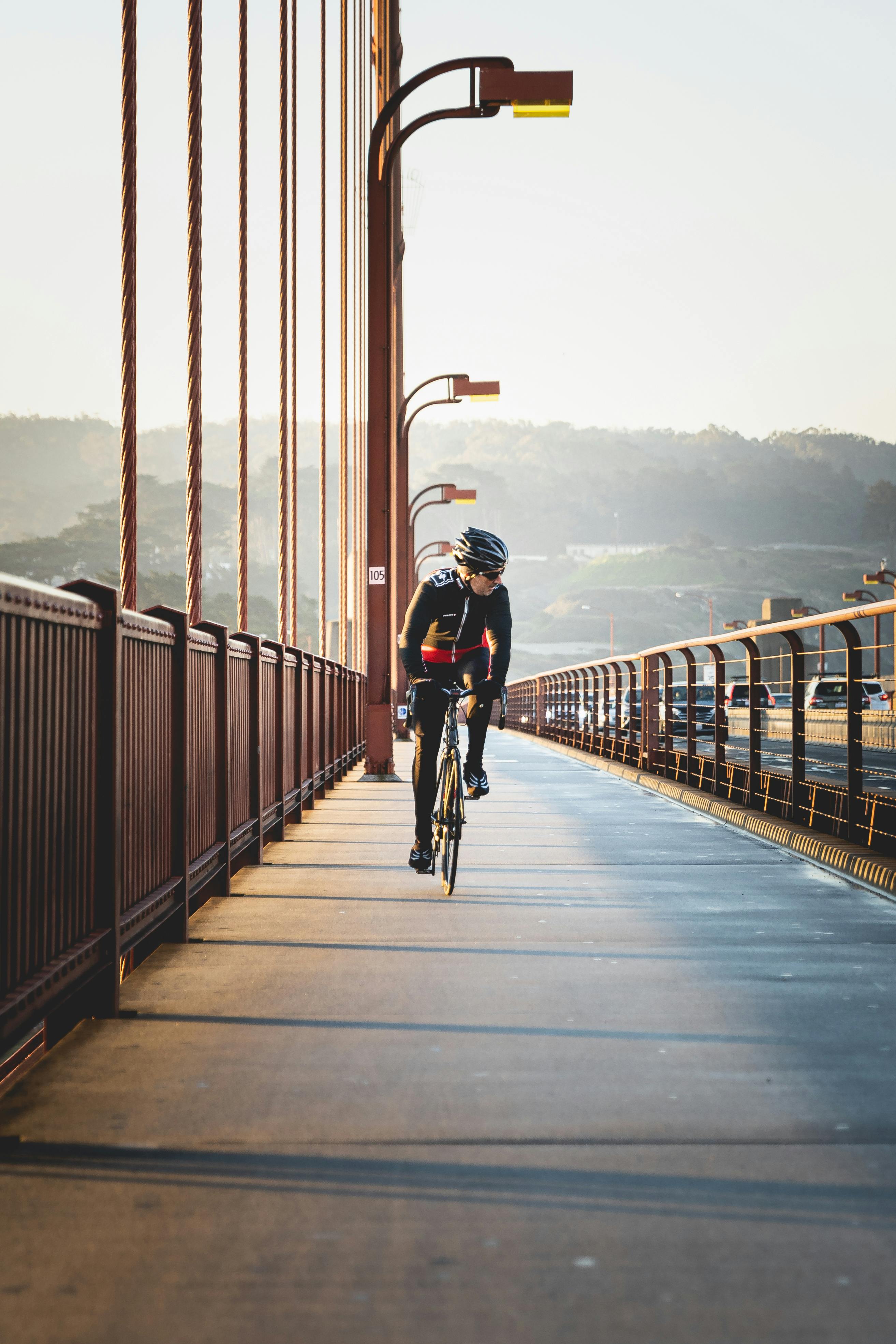 Man Riding a Bicycle on Bridge · Free Stock Photo
