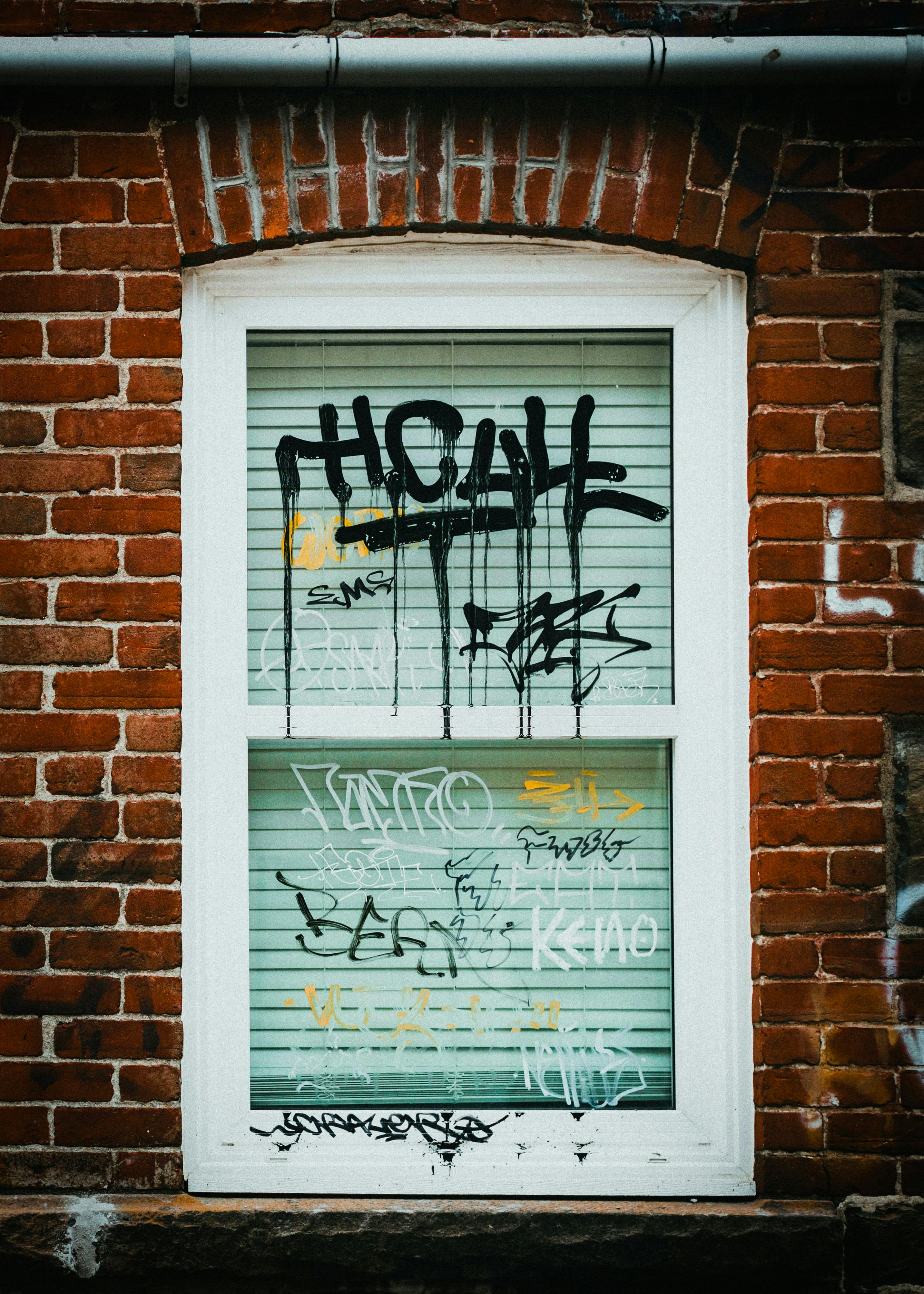 Vintage Brick Wall with Graffiti on Window · Free Stock Photo