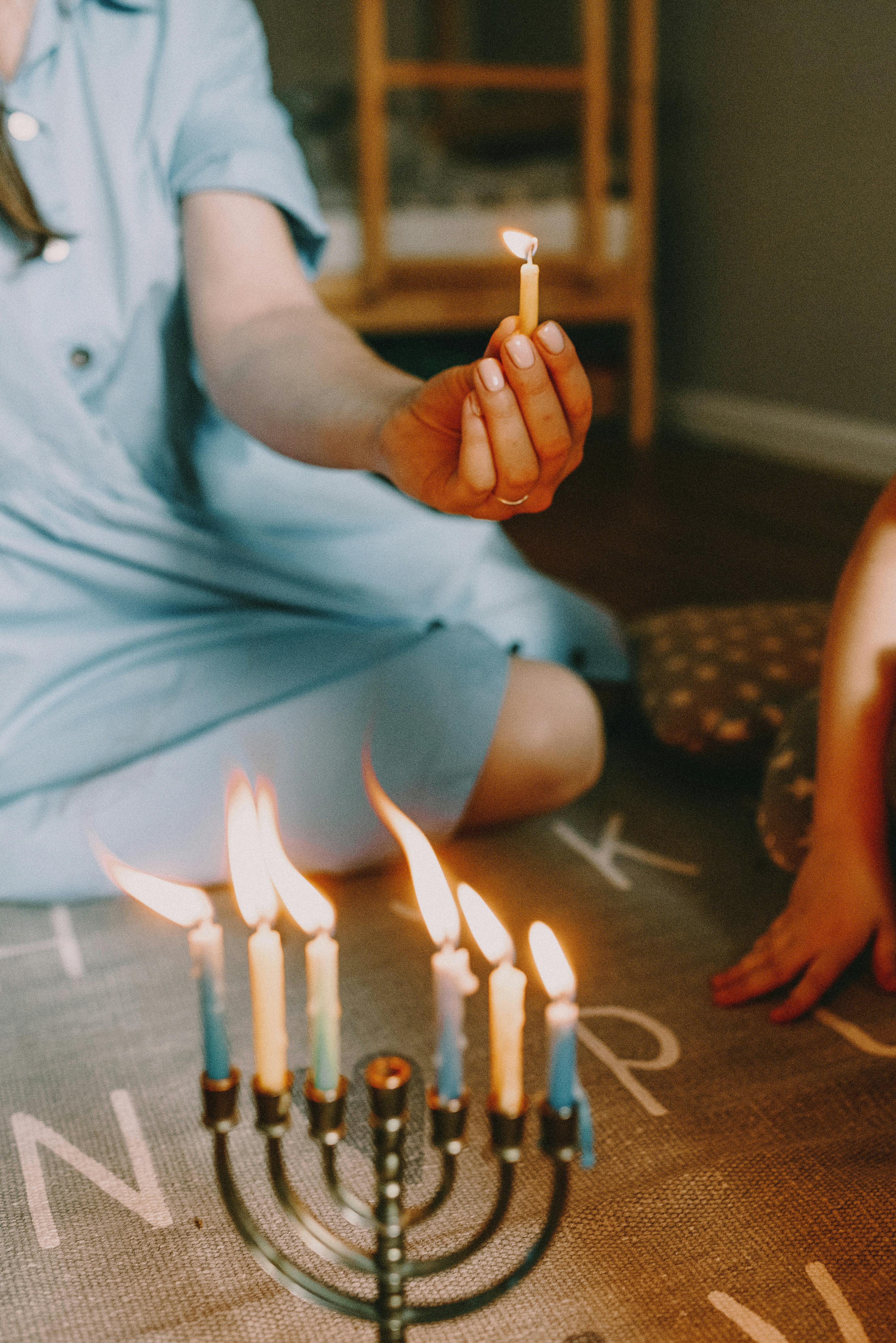 Person Lighting Menorah · Free Stock Photo