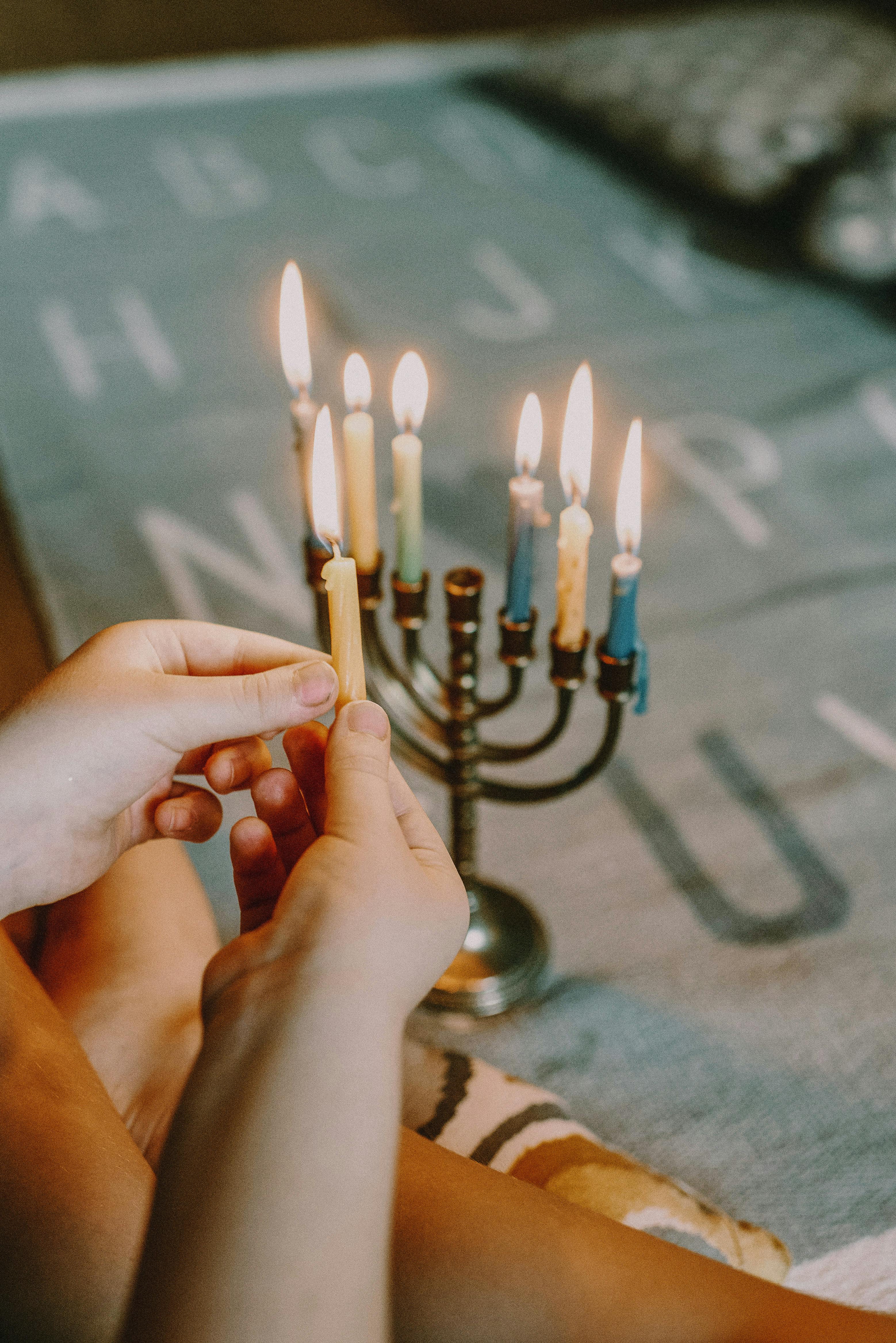 Person Lighting Menorah · Free Stock Photo