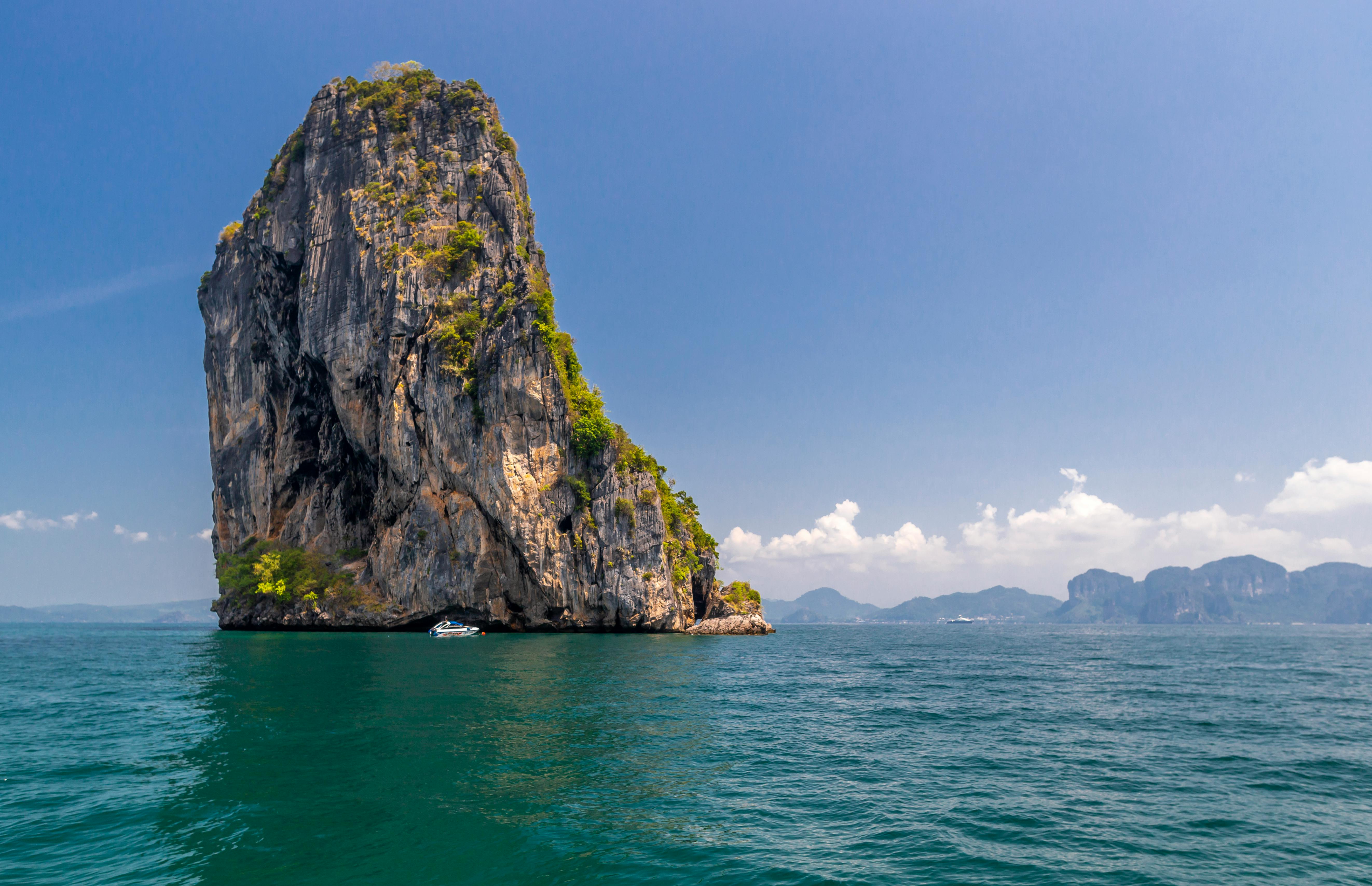 Natural Rock Formation on Sea Under Blue Sky · Free Stock Photo