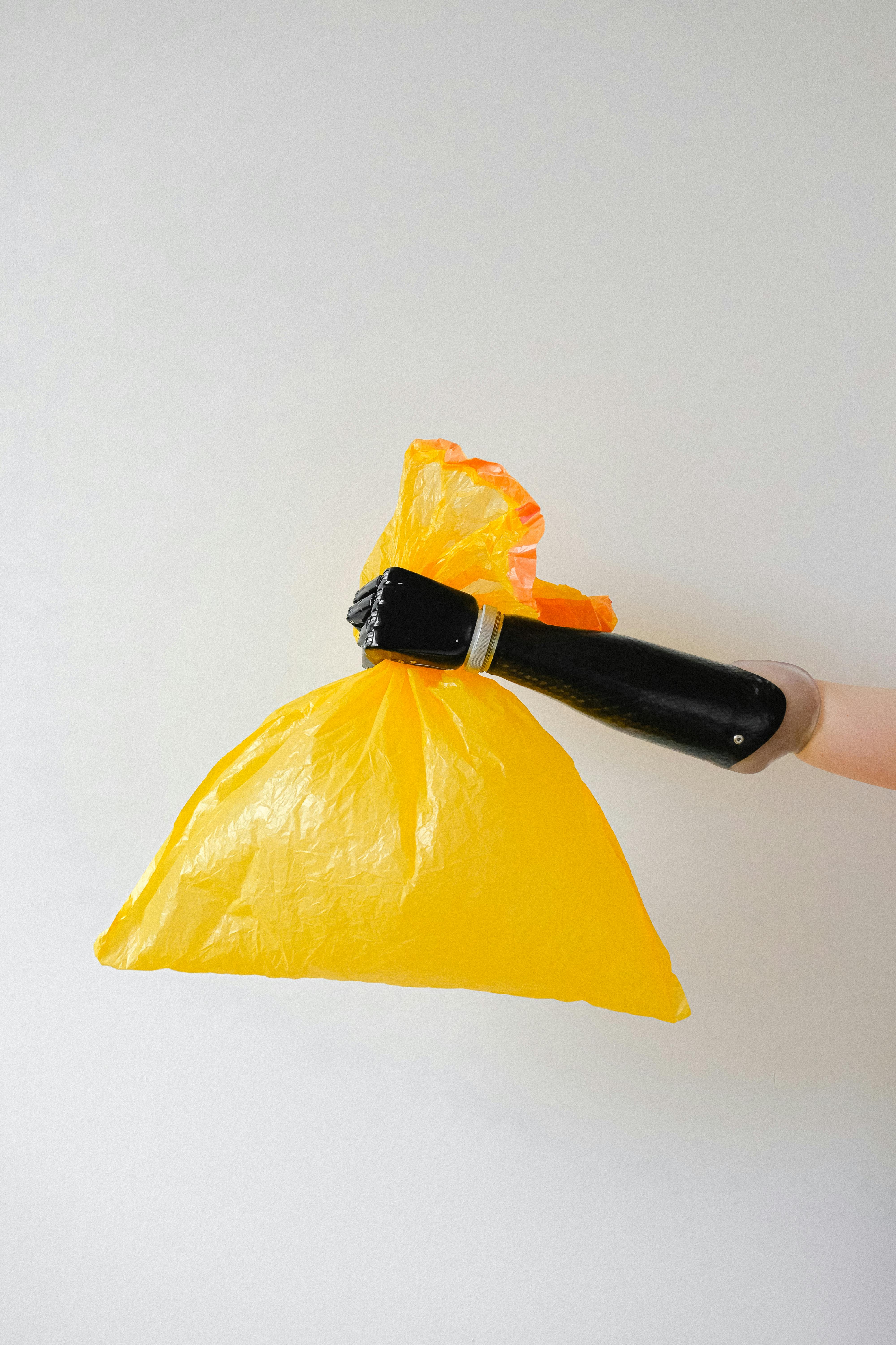 Person Holding Yellow Plastic Bag With One Hand · Free Stock Photo