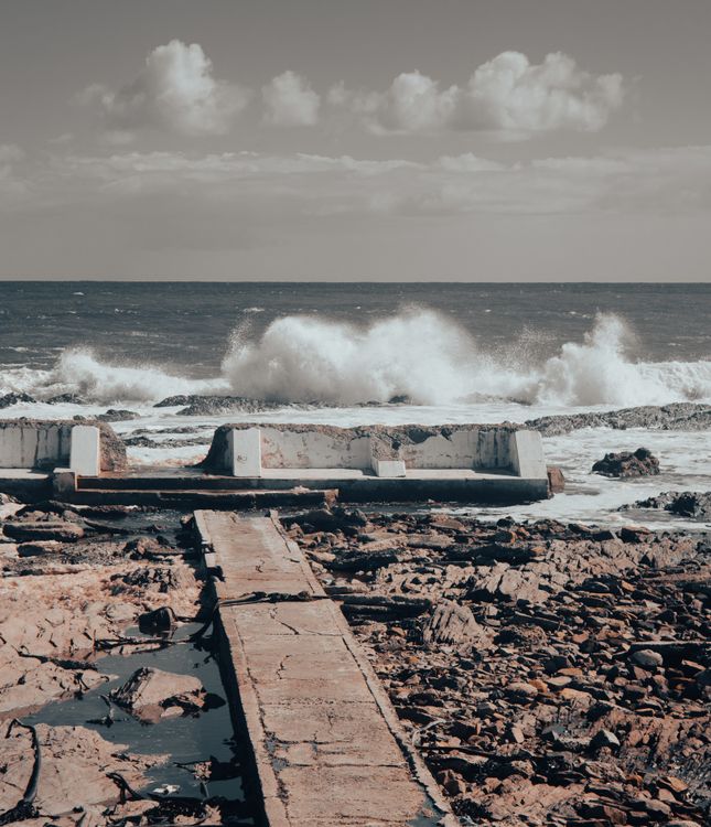 Seaside Ruins with Crashing Waves and Dramatic Sky · Free Stock Photo