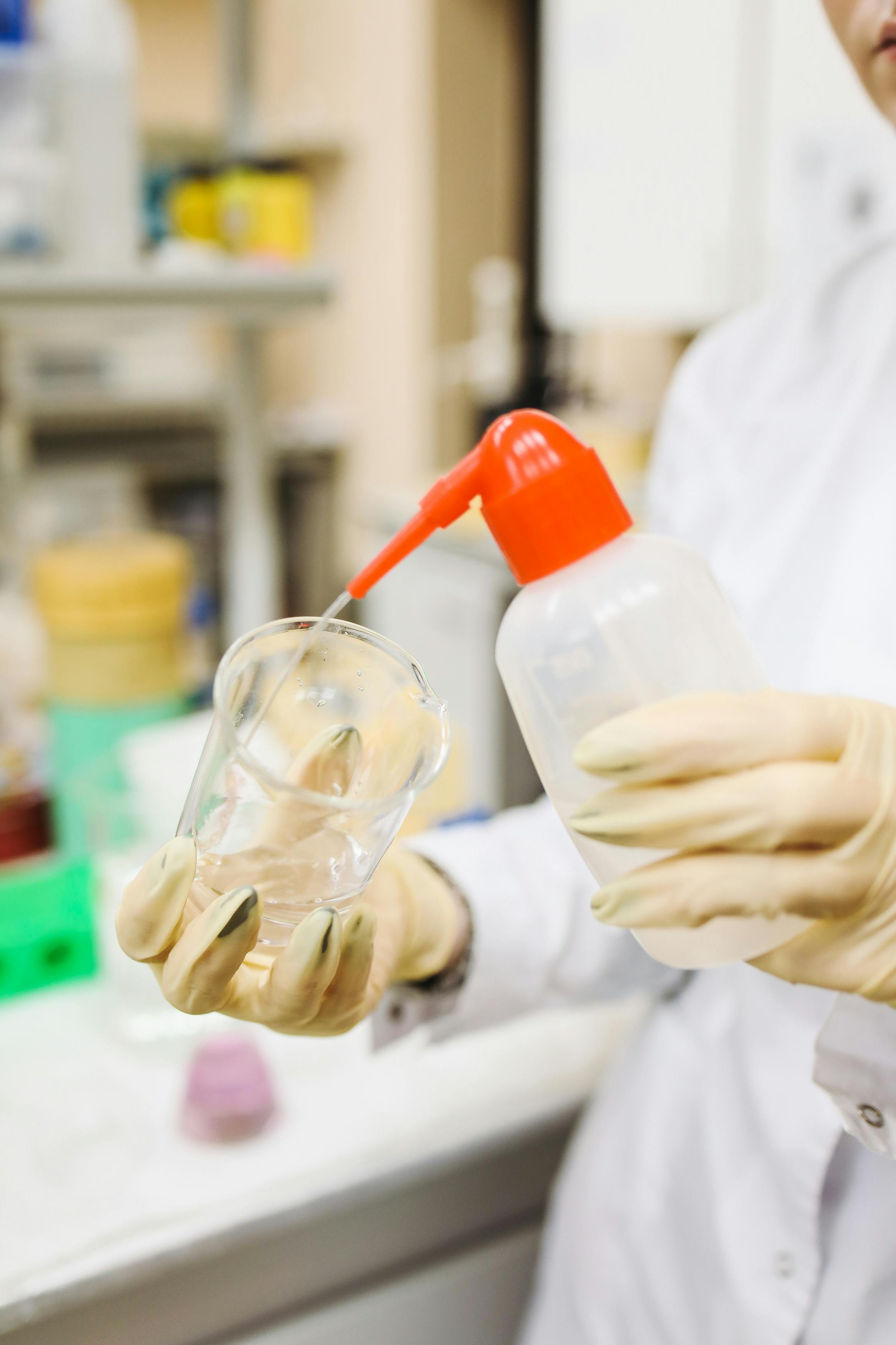 Person Holding Beaker · Free Stock Photo