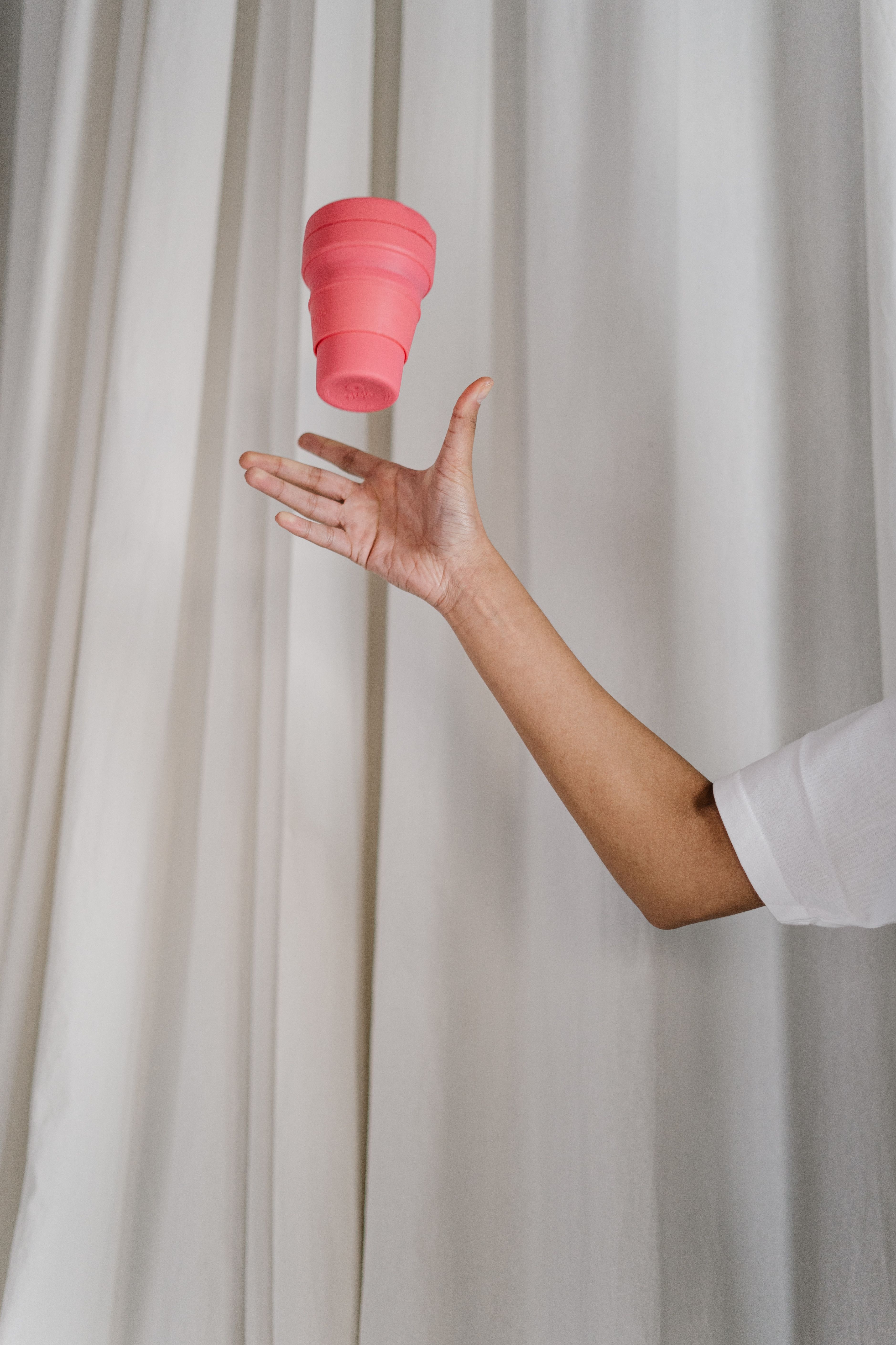 Person Catching Pink Plastic Cup · Free Stock Photo