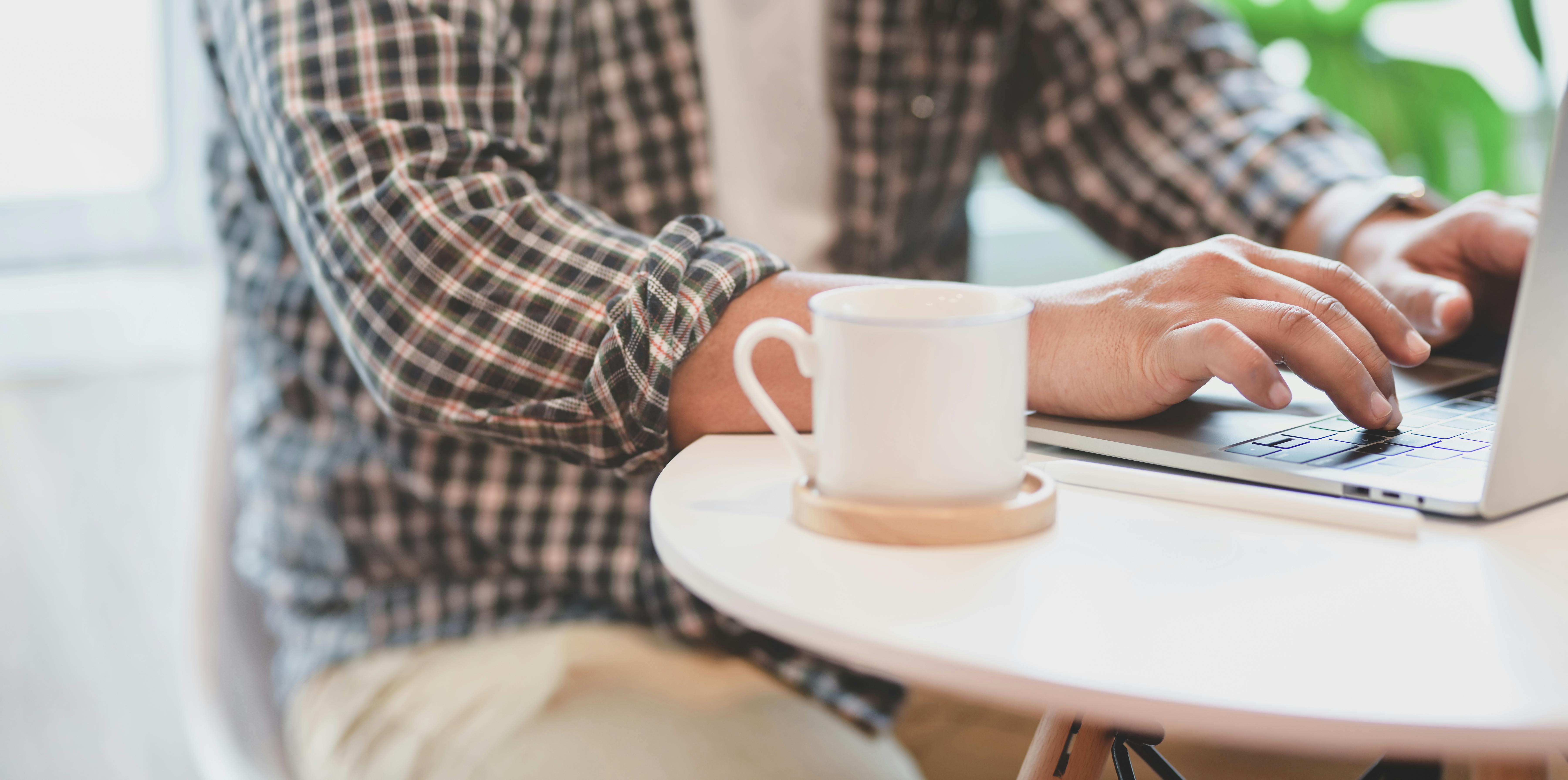 Man in Red Long Sleeve Shirt Using Laptop Computer · Free Stock Photo