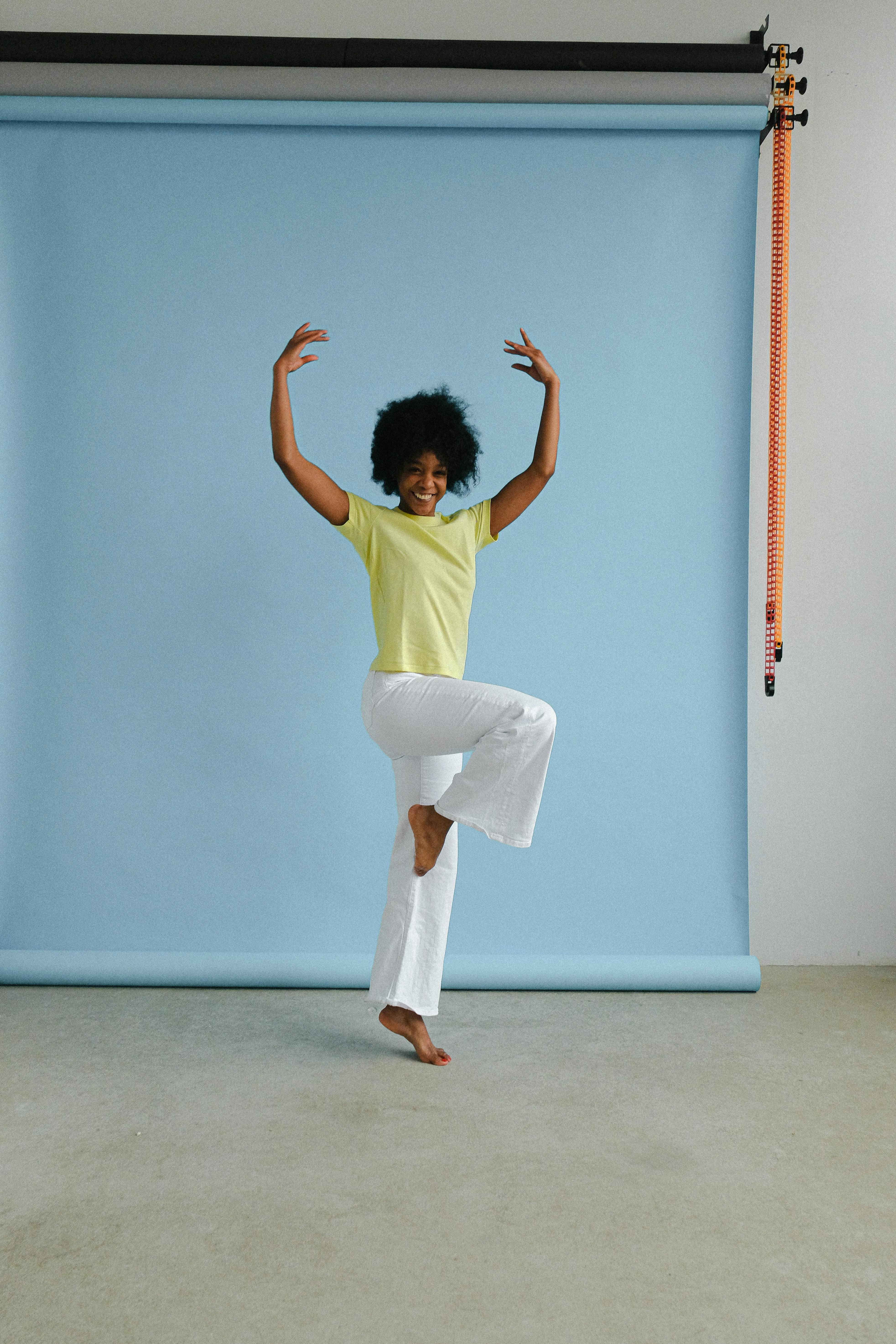 Woman in White Pants Standing on Concrete Floor · Free Stock Photo
