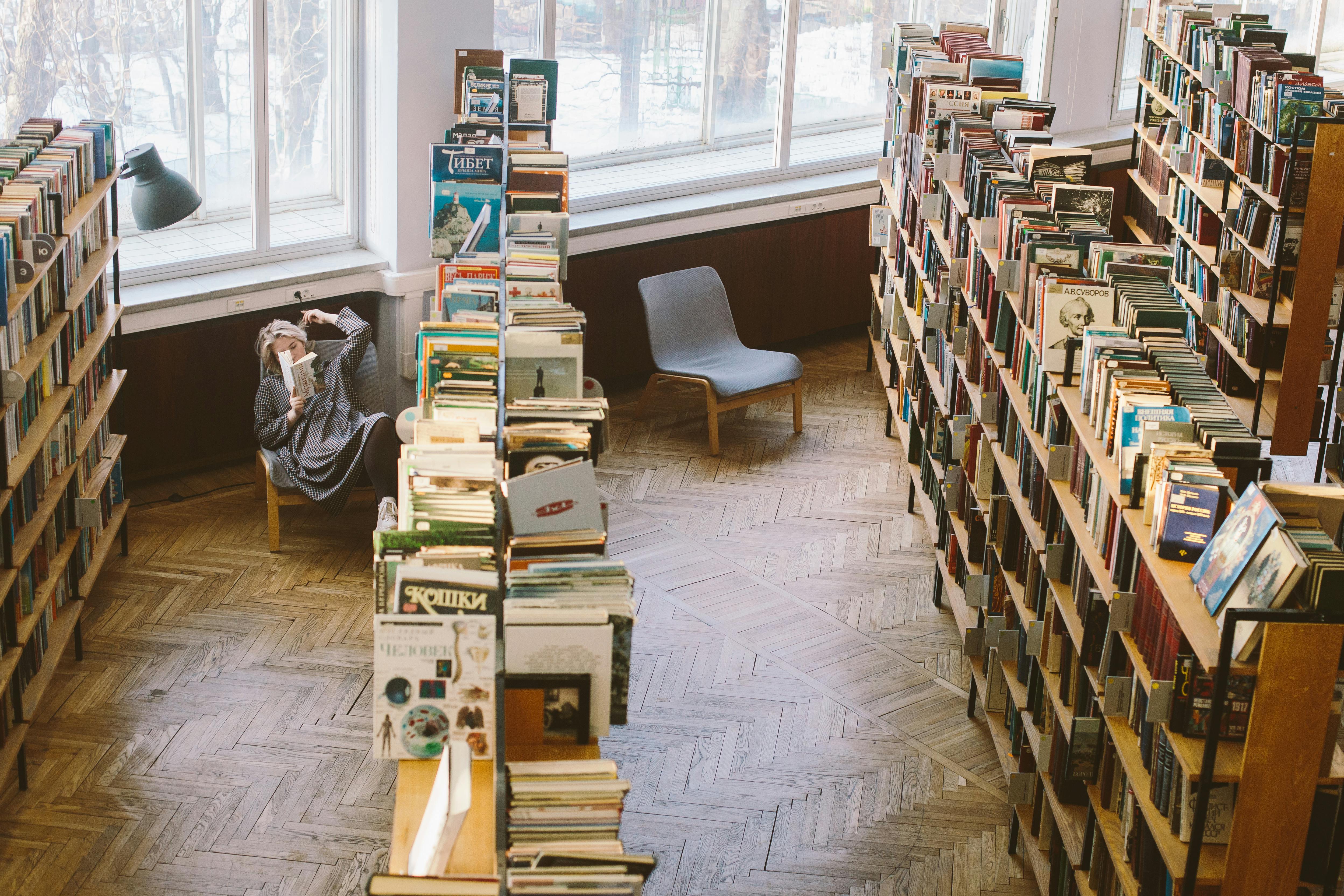 Woman Reading in Library · Free Stock Photo
