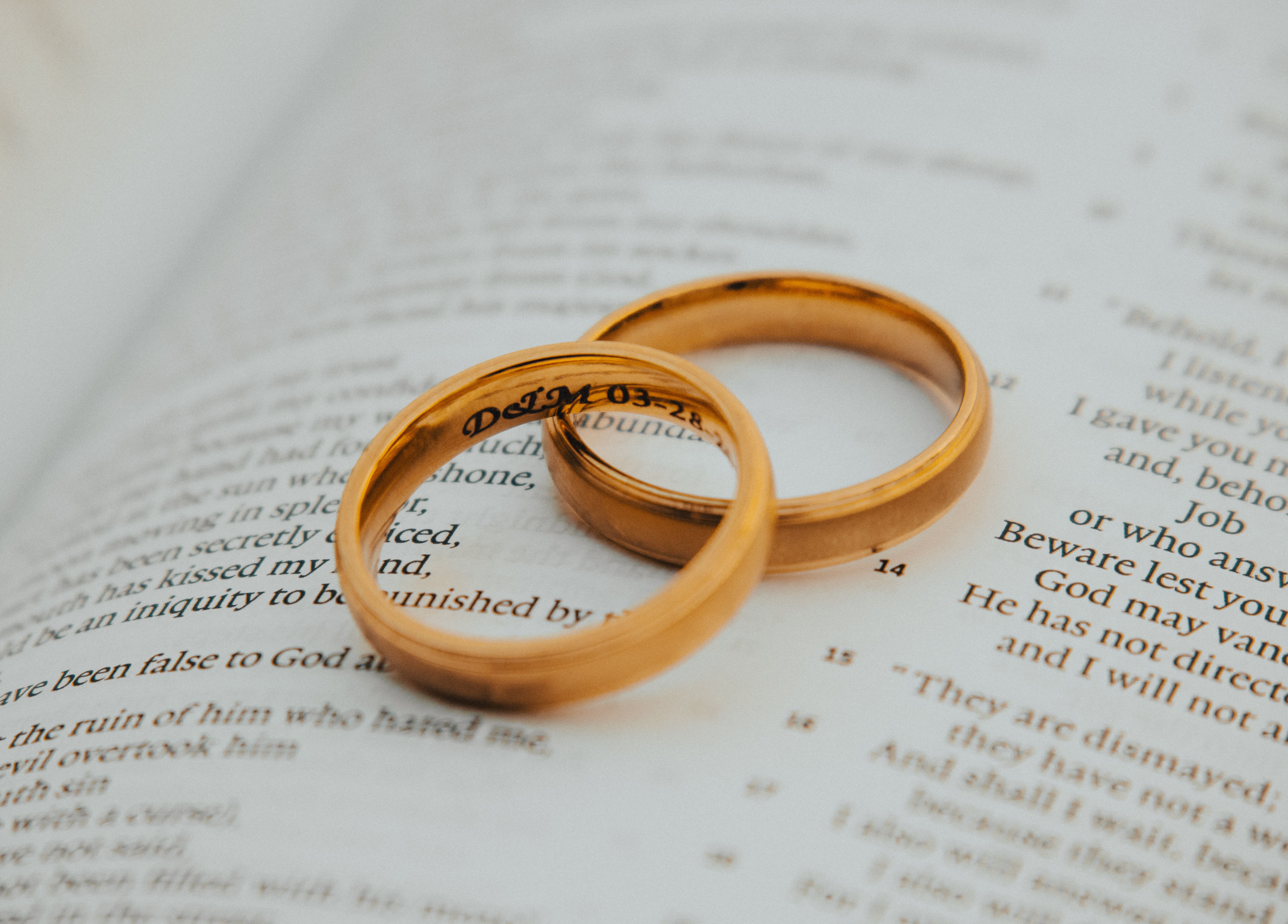 Golden Wedding Rings on Holy Bible Cover · Free Stock Photo